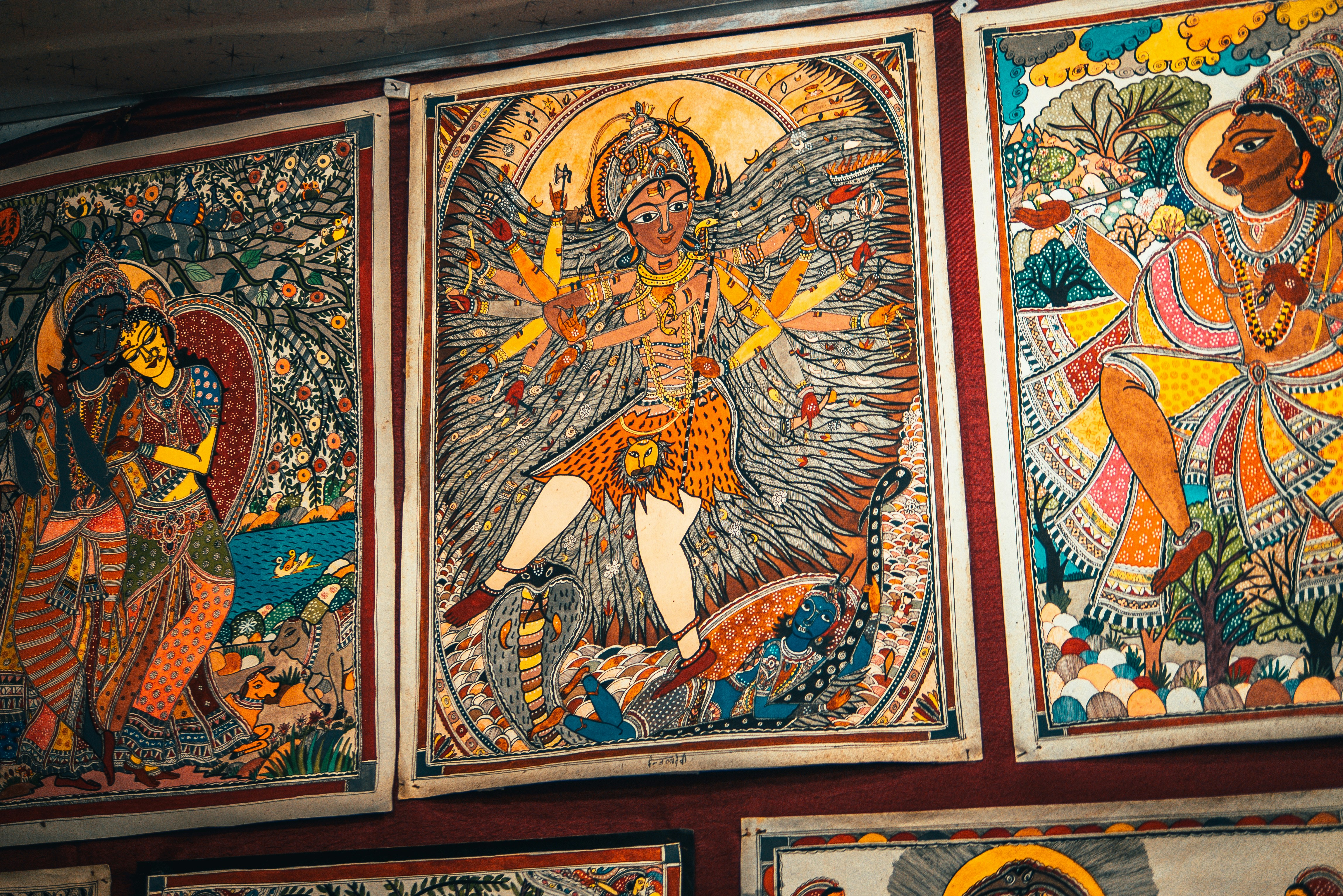 Armed Deva in a Vivid Indian Folk Tapestry Trio
