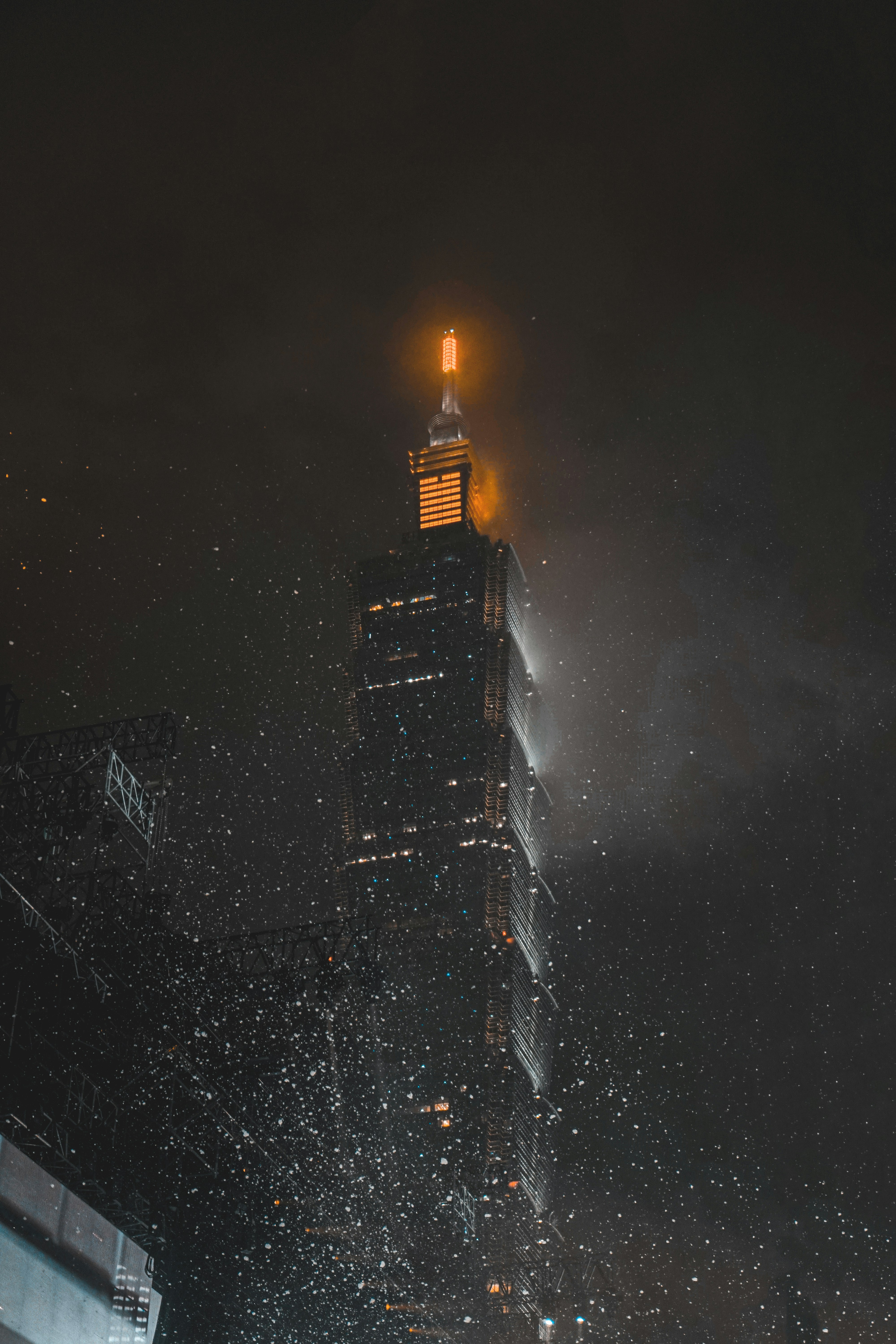 Fireworks display over high rise building during night time photo ...