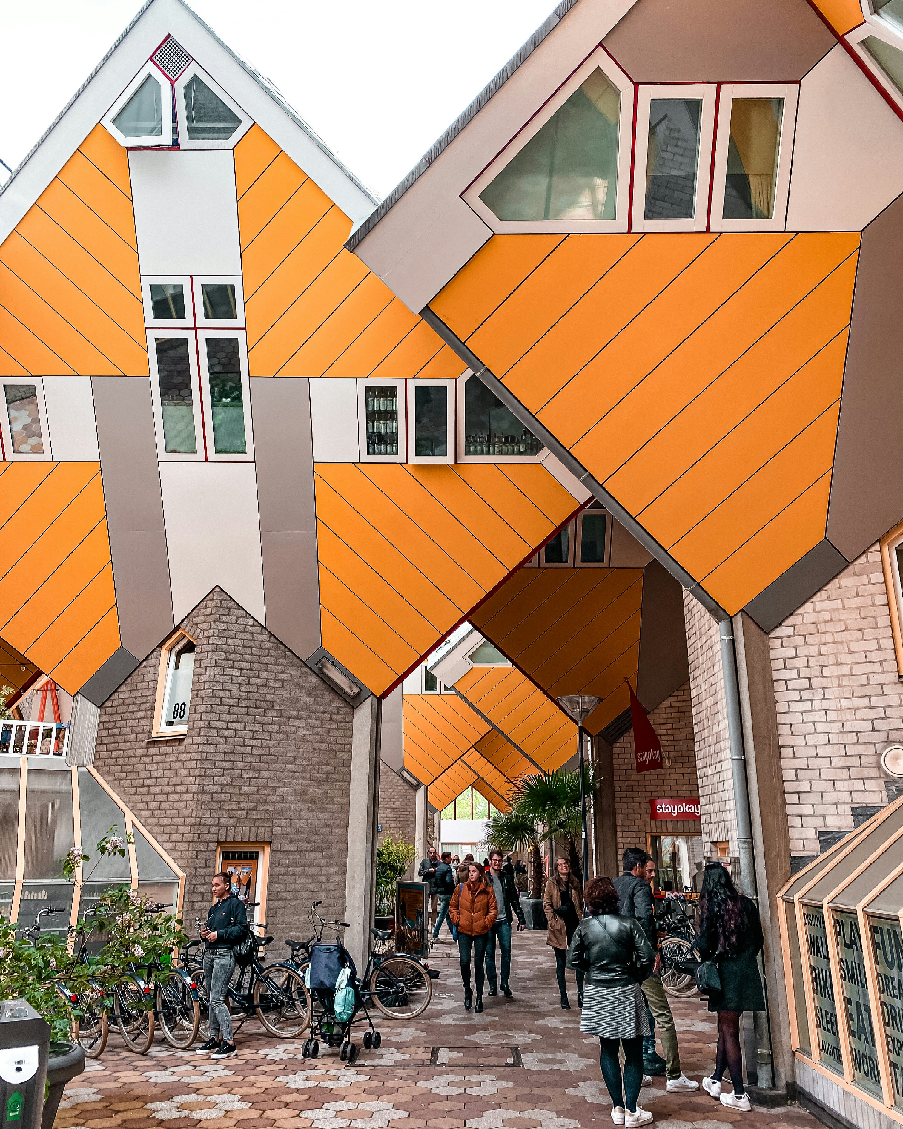 Orange Diagonal Canopy: A Street Framed by Intersecting Facades