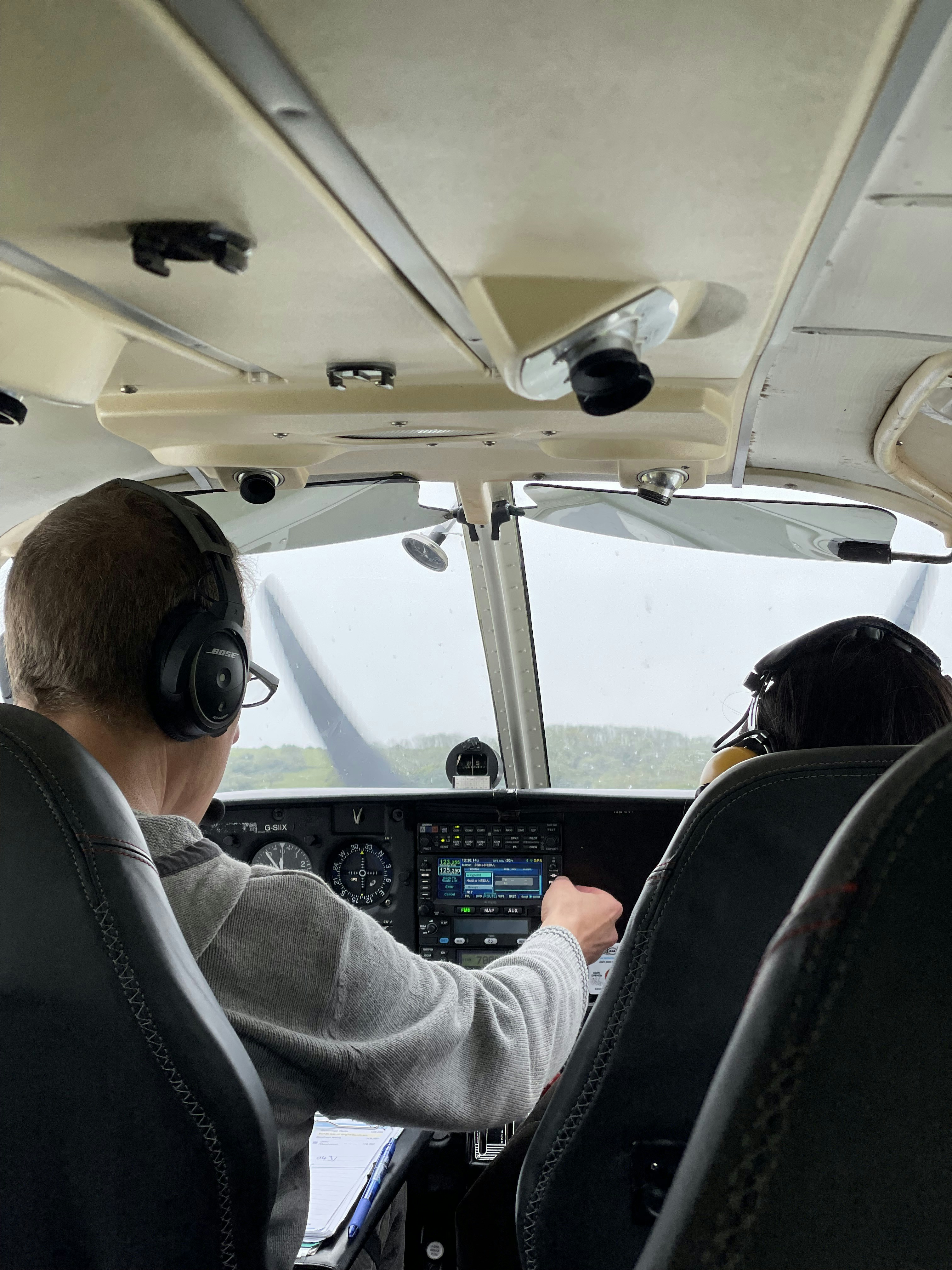 Two-Pilot Cockpit: Focus on the Glass Panel Amid Soft Cabin Light