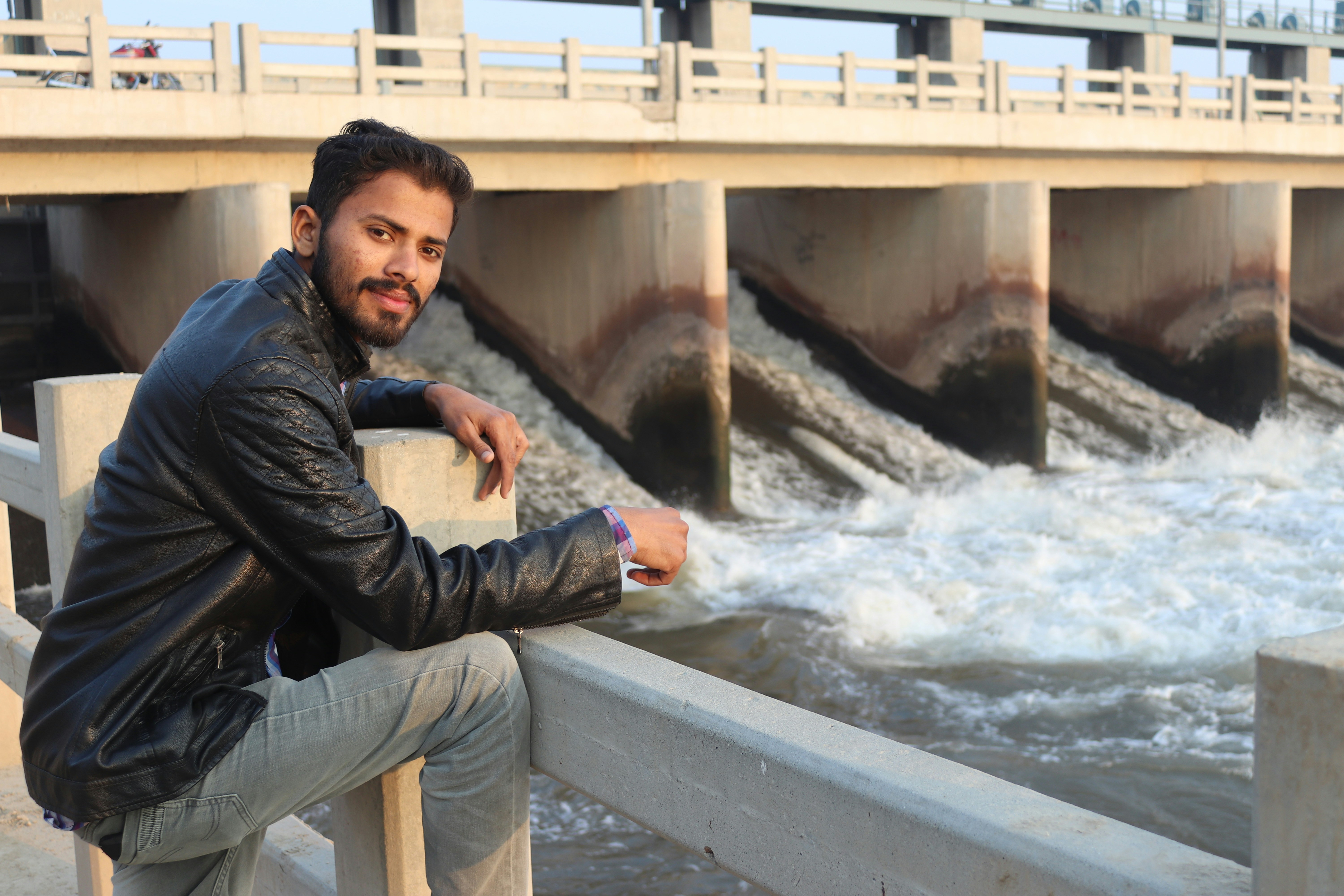 Riverside Stillness: Portrait on the railing by the spillway