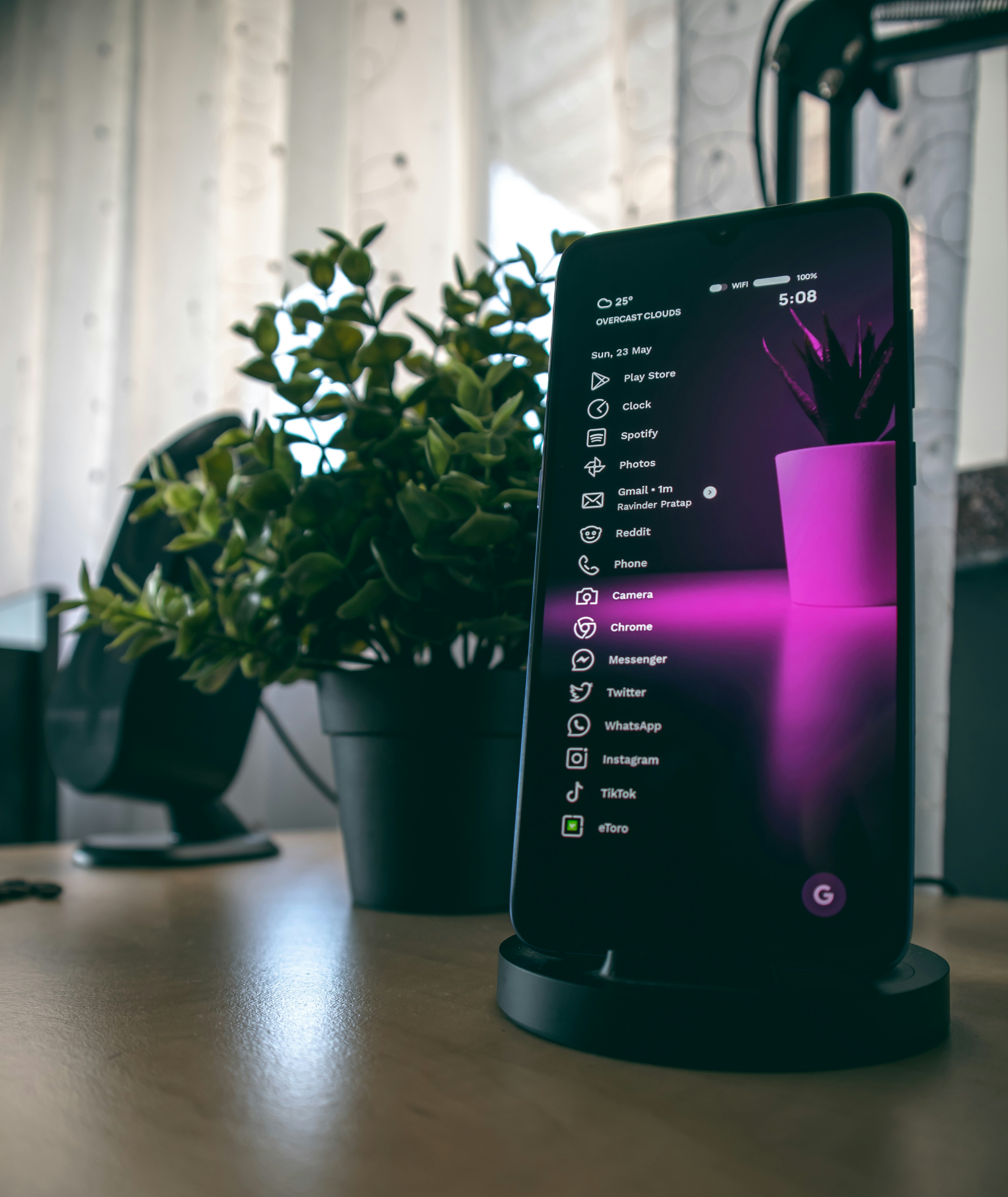 Glowing Screen, Quiet Desk: A Smartphone Stand Illuminating a Plant Corner