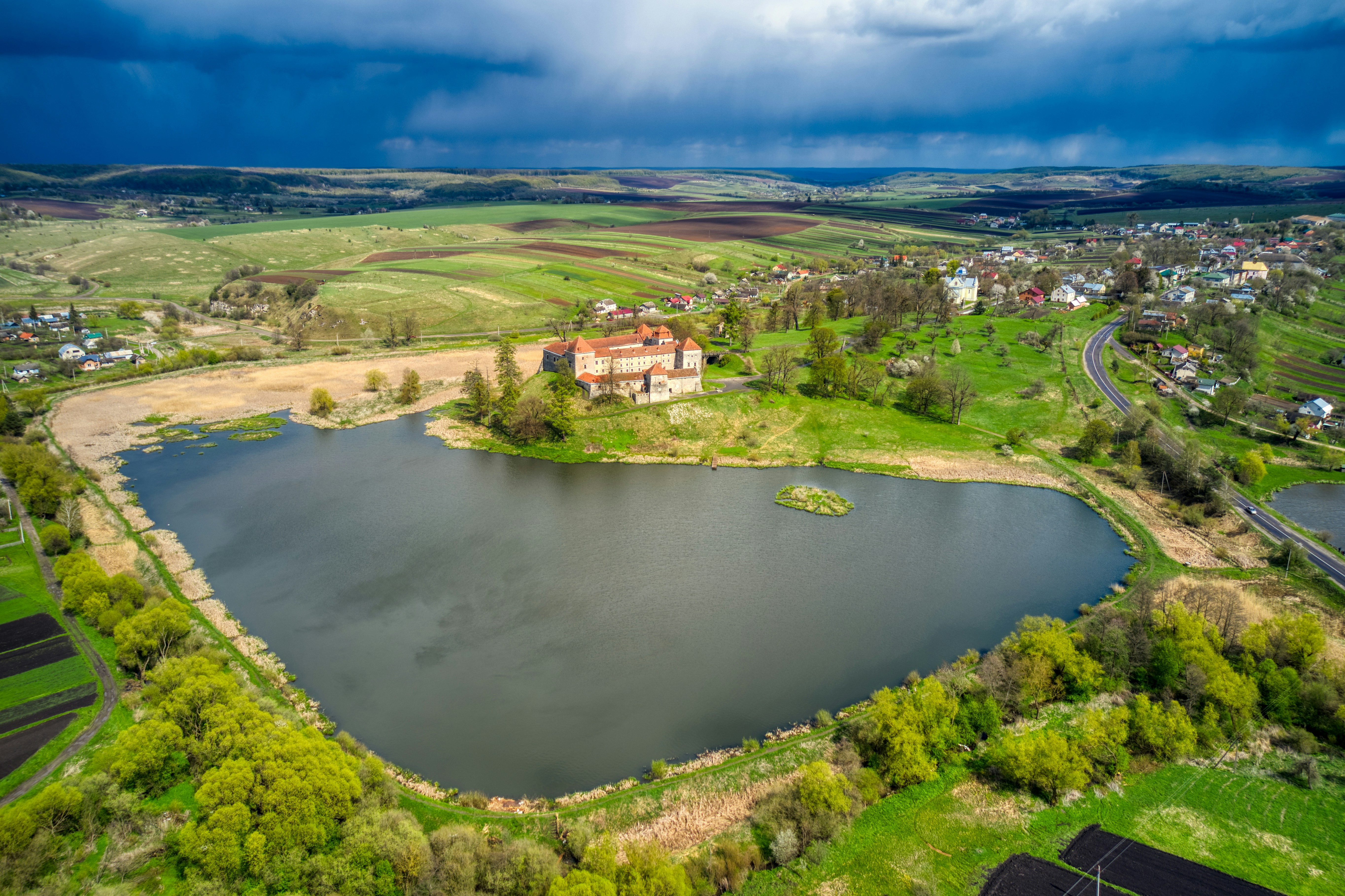 Aerial view of green grass field near lake during daytime photo – Free ...