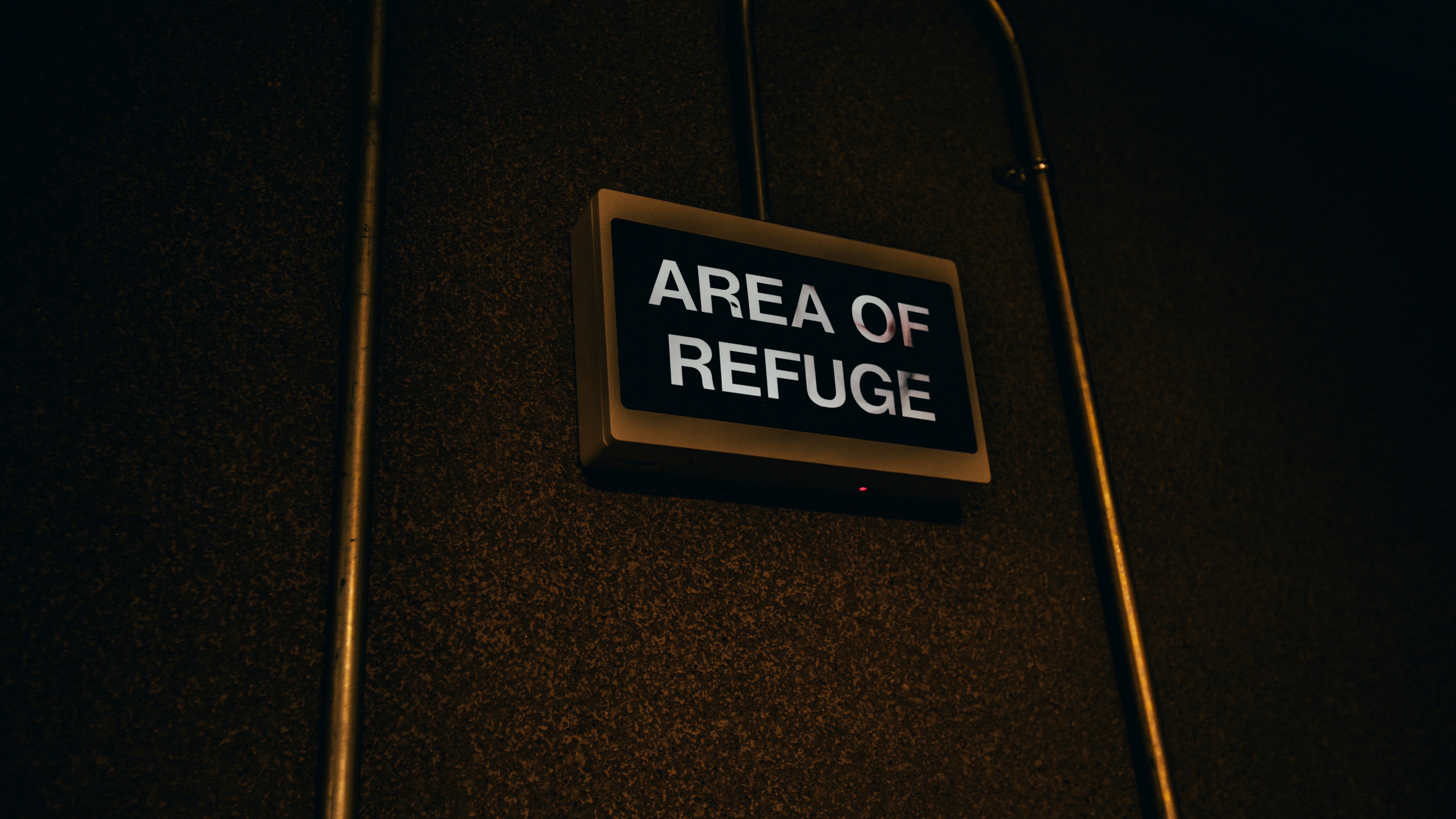 A sign on a wall that says area of refuge photo – Free Take cover Image ...