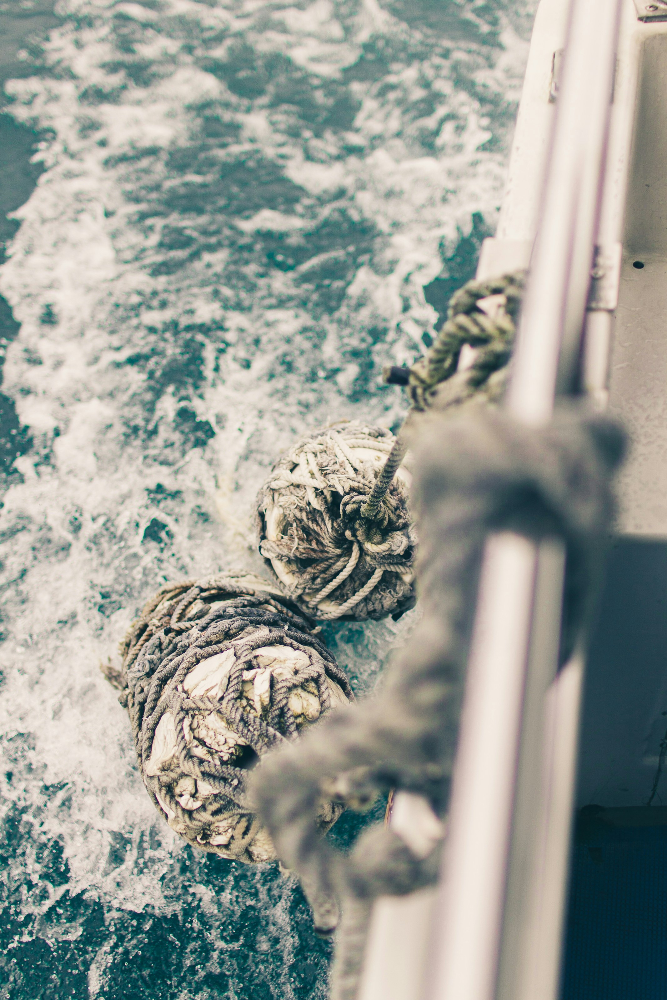 Roped Buoy and Turbulent Sea: A Vessel’s Quiet Moment