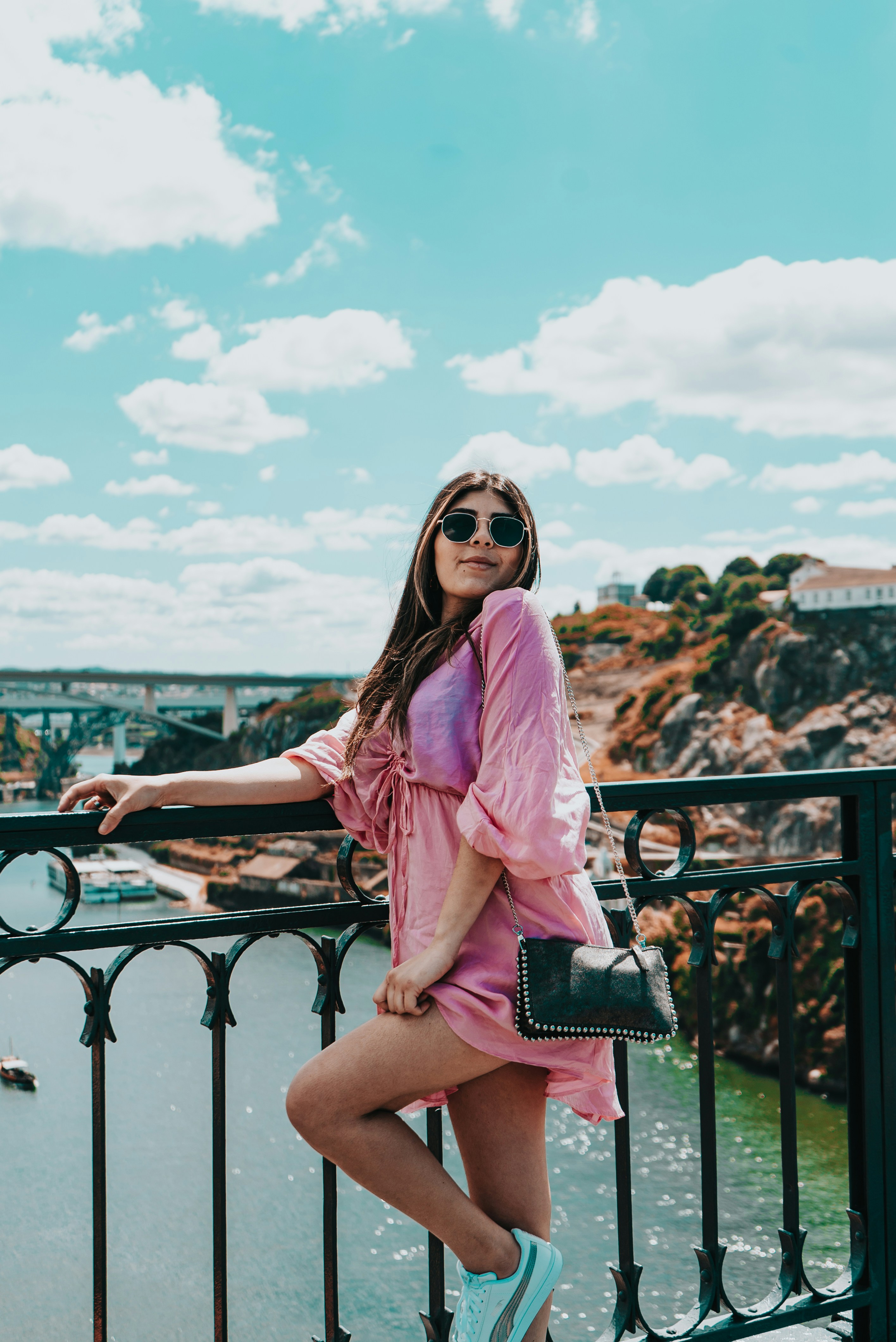 Pastel Pose by the Waterfront Rail under a Cerulean Sky
