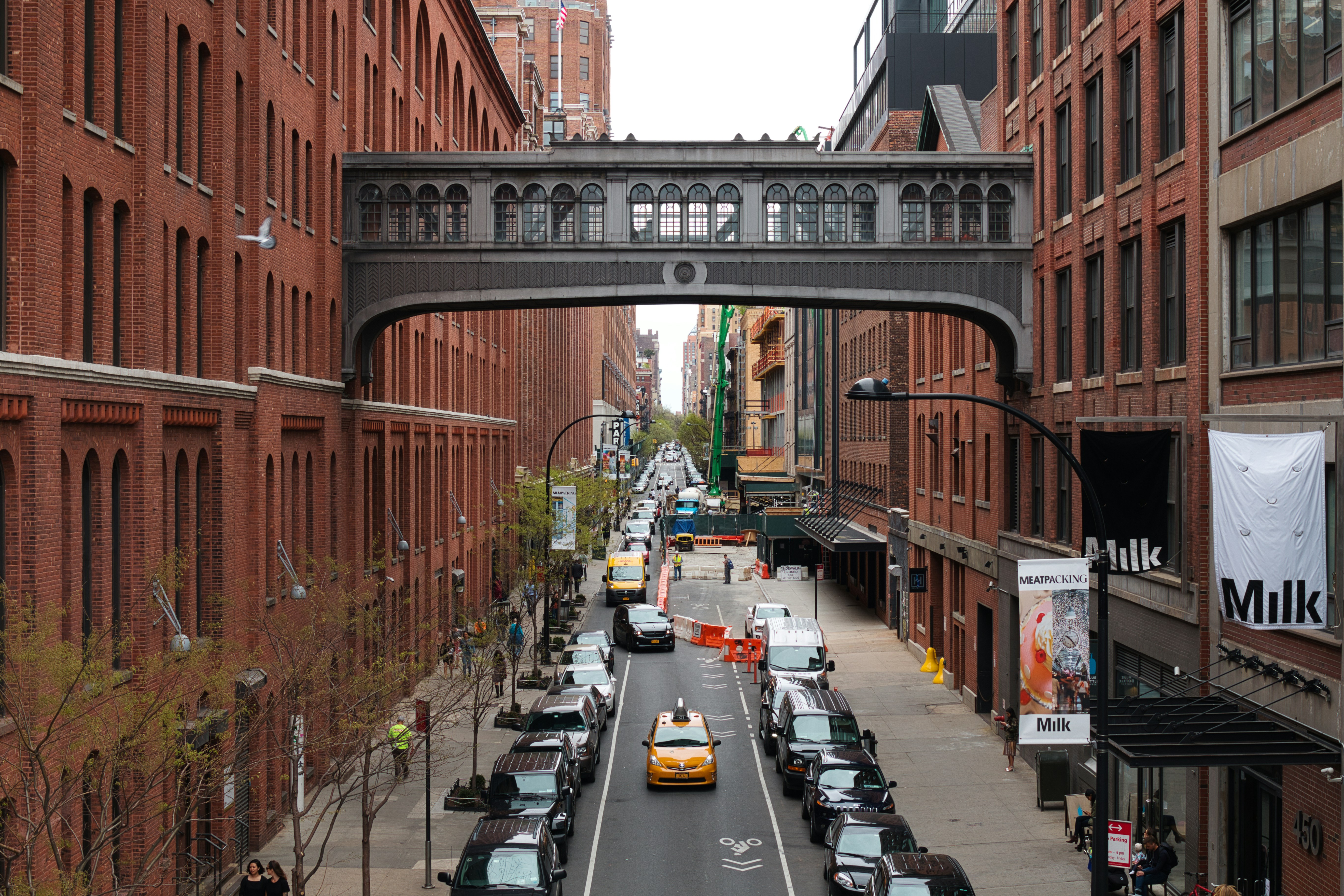 Brick Canyon Under a Steel Skybridge