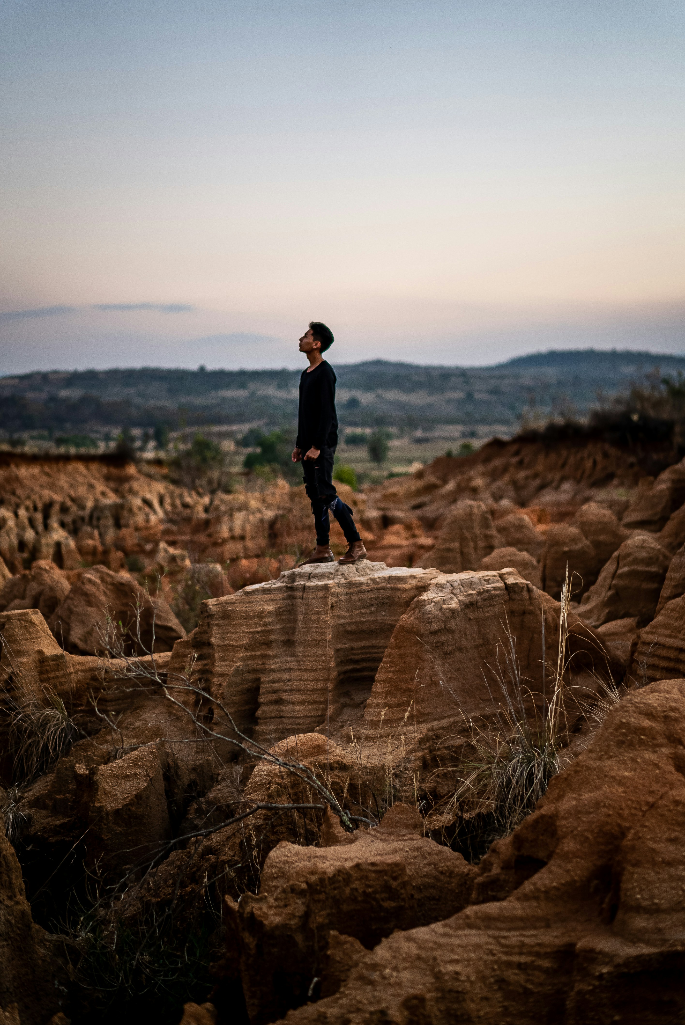 Solitary climber on wind-carved hoodoo spires at golden hour