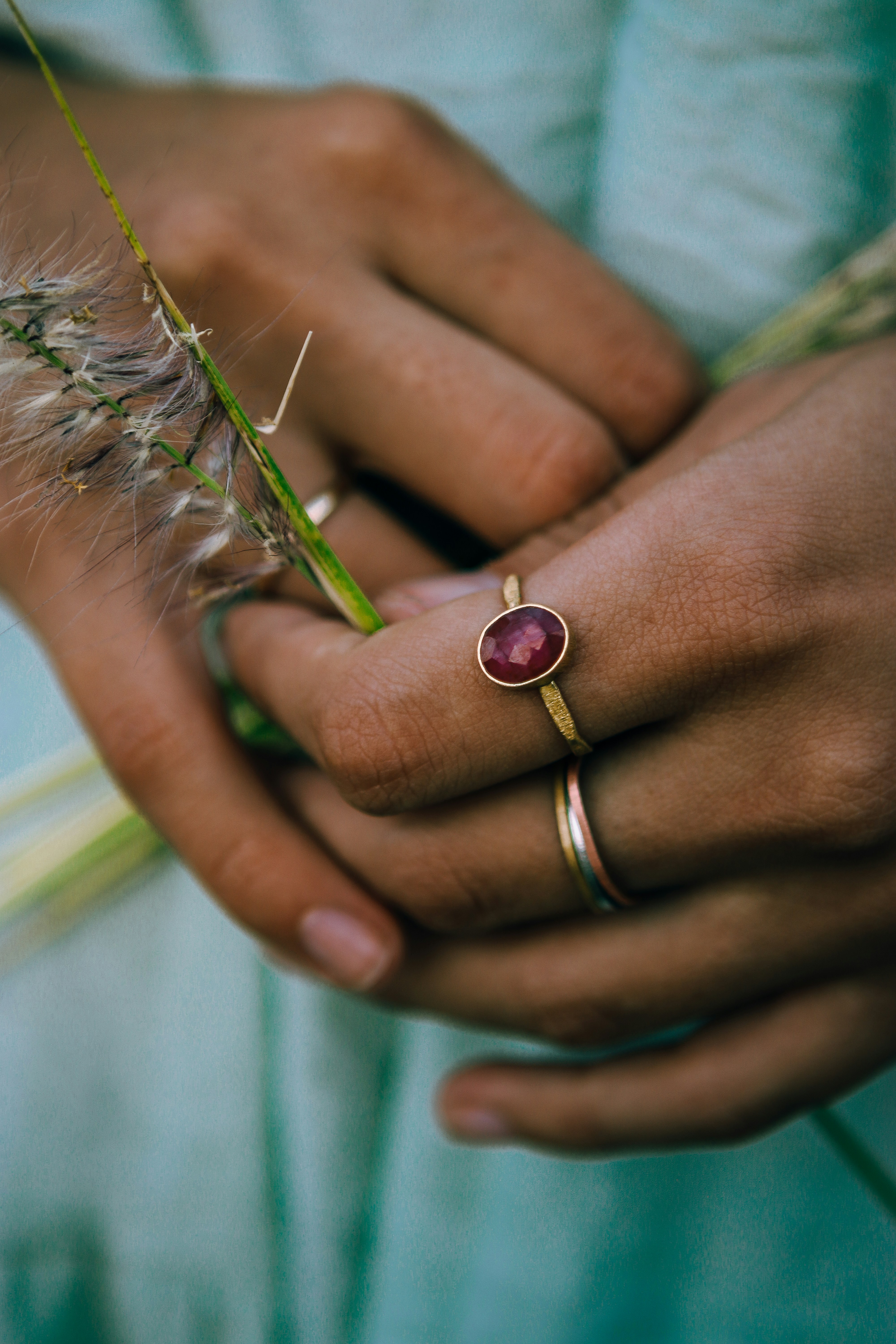 Crimson Ruby in Quiet Hands Amidst Gentle Grass