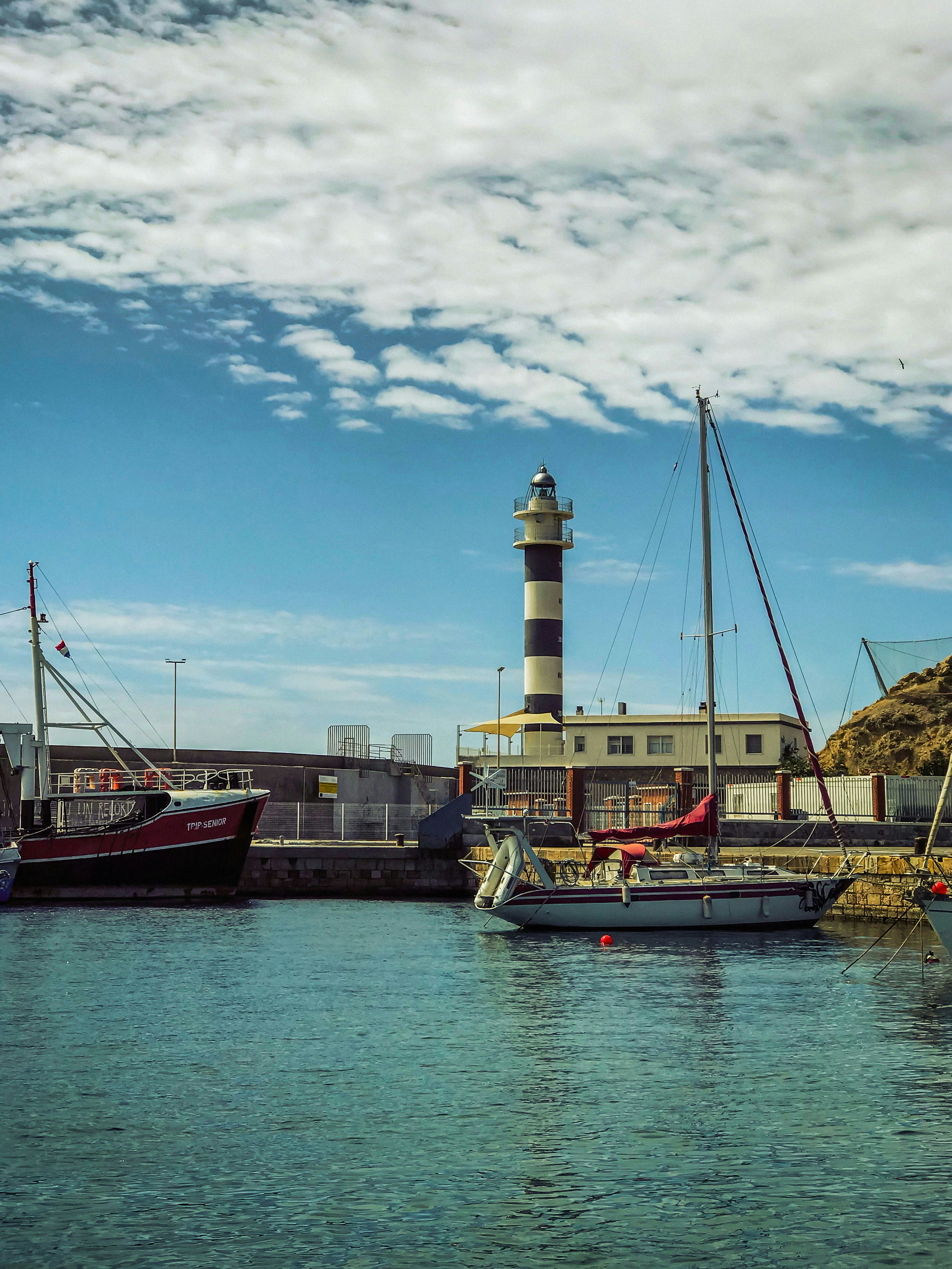 Beacon of Stripes: A Quiet Harbor Under a Bright Sky