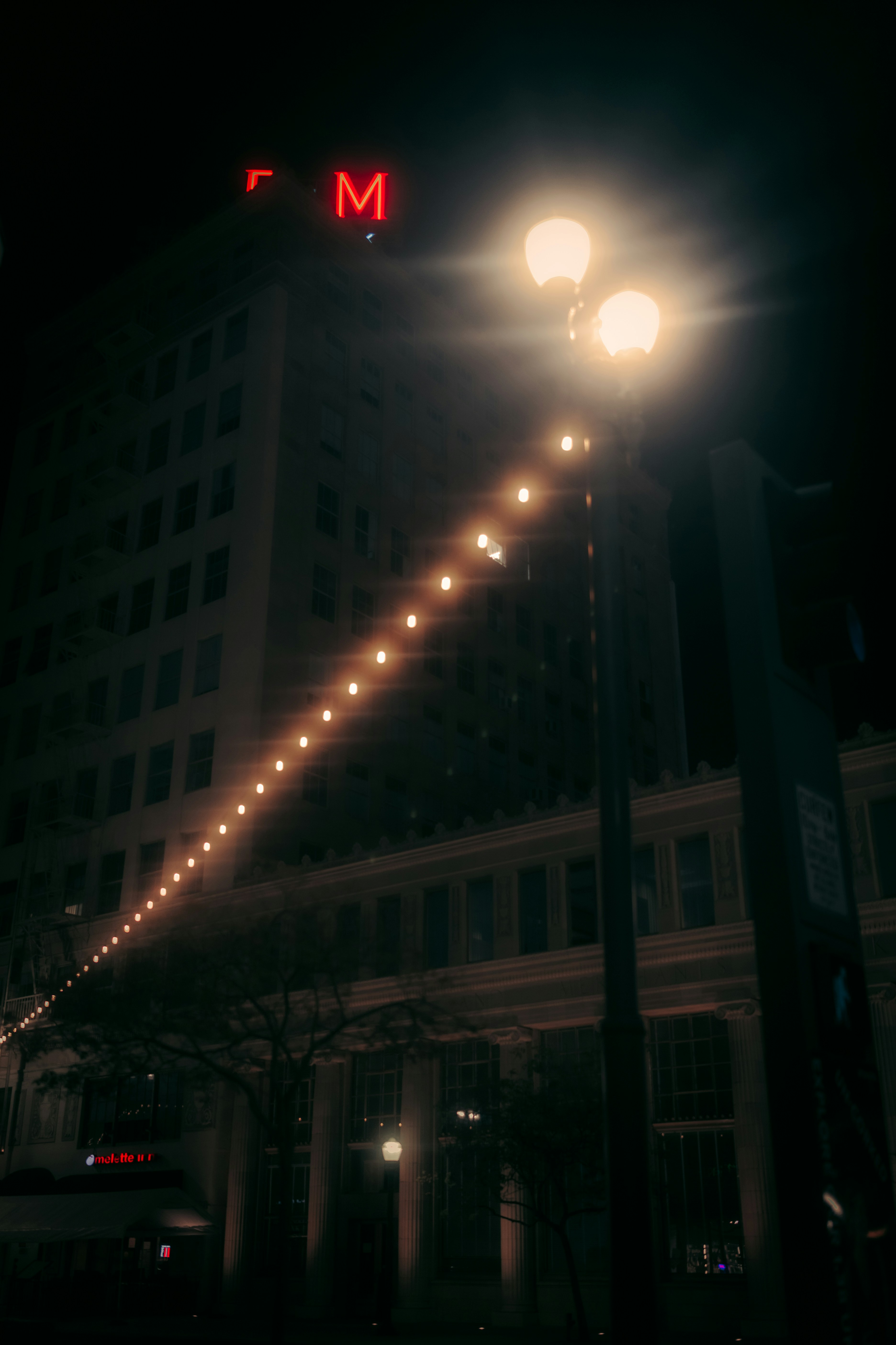 Lantern Line: Night Streetlamps along a Quiet Urban Lane