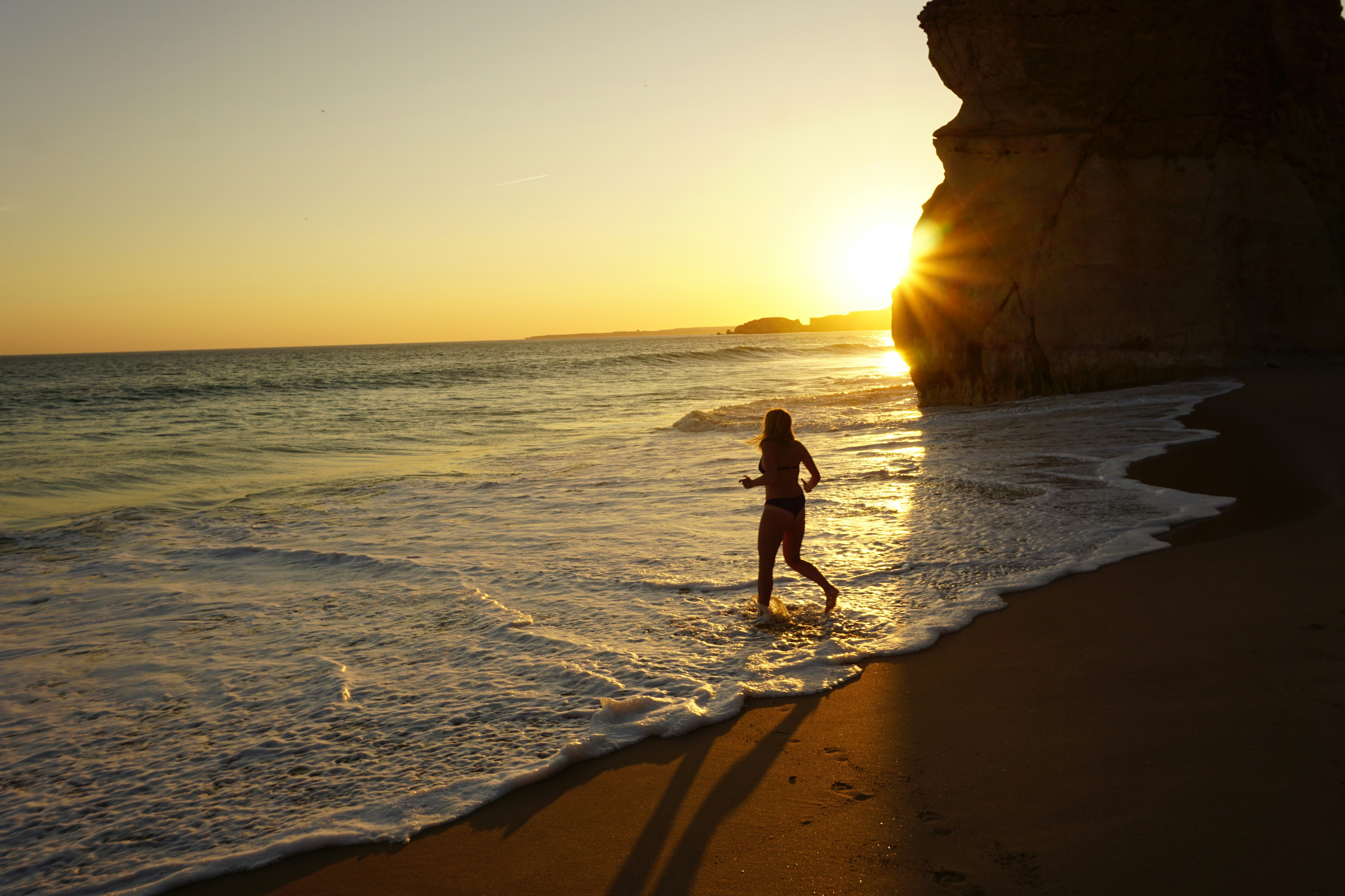 Sunlit Silhouette: A Runner at the Edge of Dusk