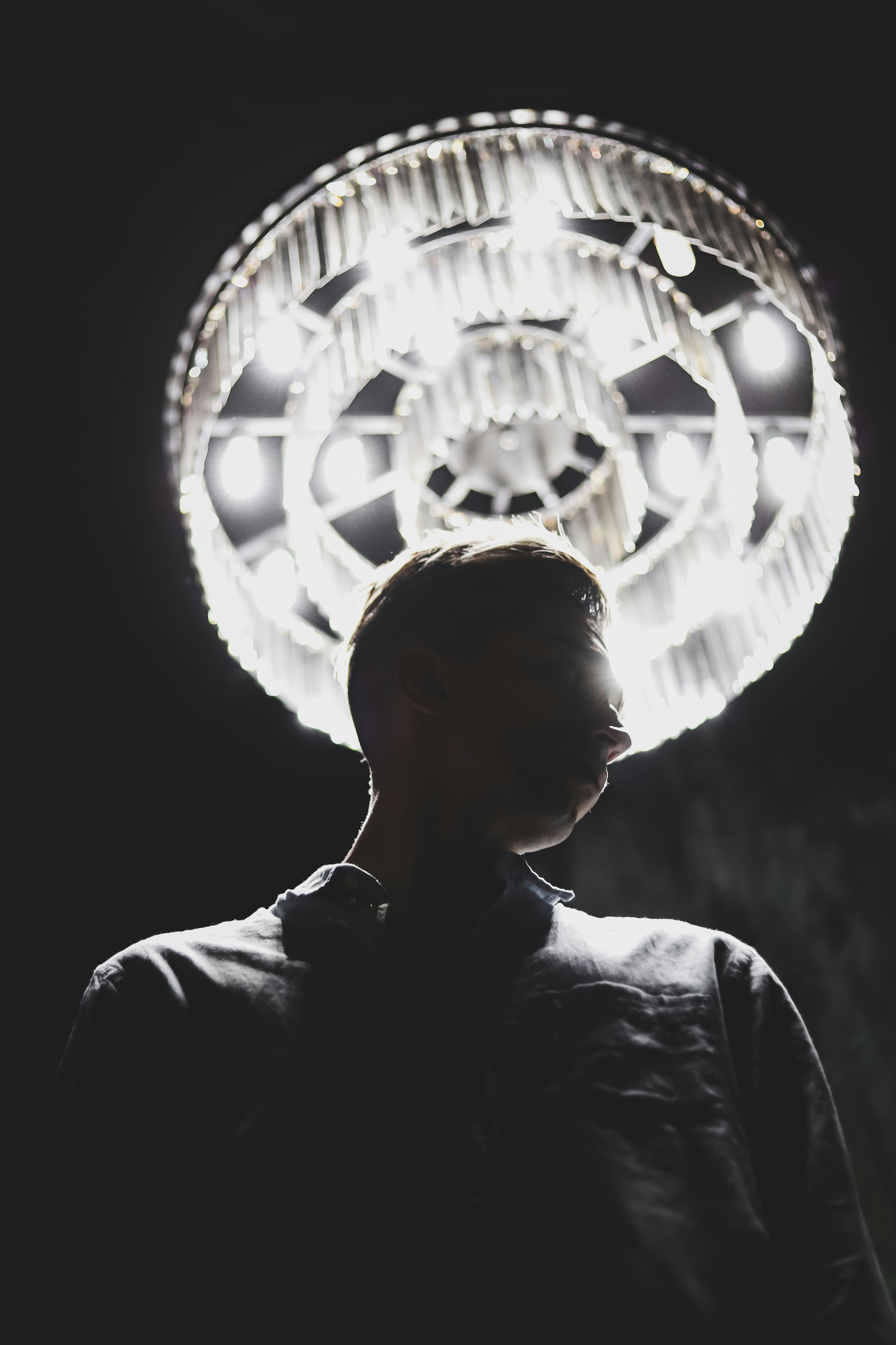 Under the Halo: Silhouette Beneath a Circular Light