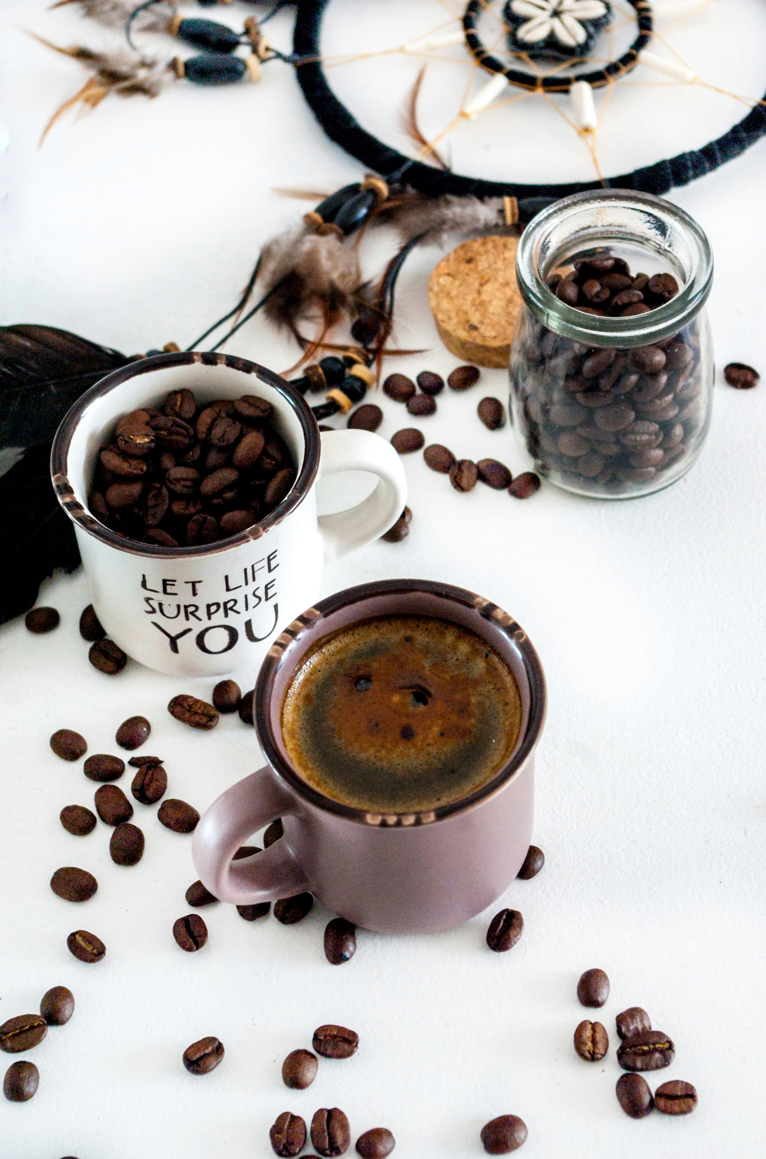 Brewing Moments on White: Three Cups, a Jar of Beans, and a Dreamcatcher