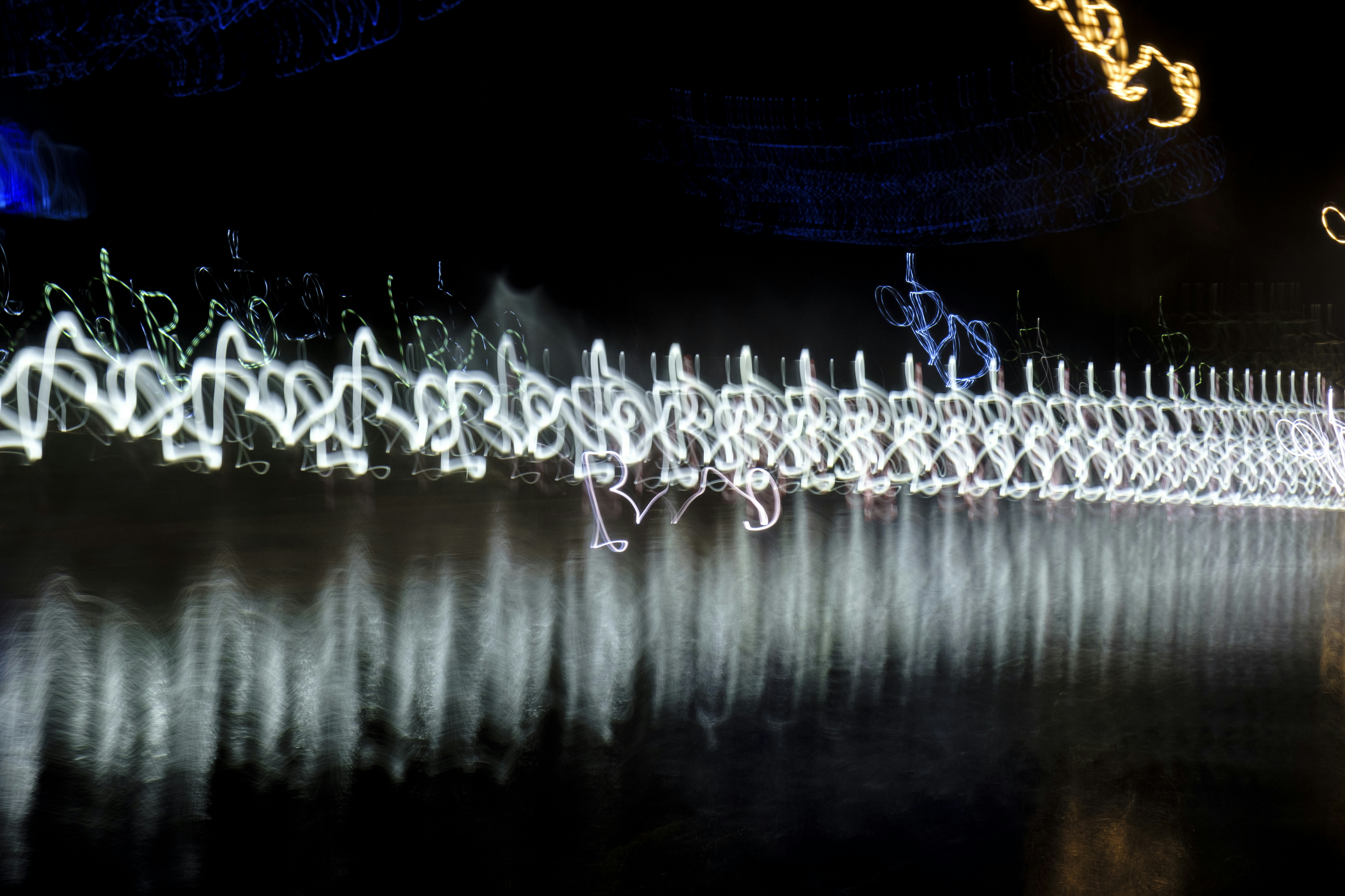 Neon Whispers on Water: A Long-Exposure Dance of City Light Trails