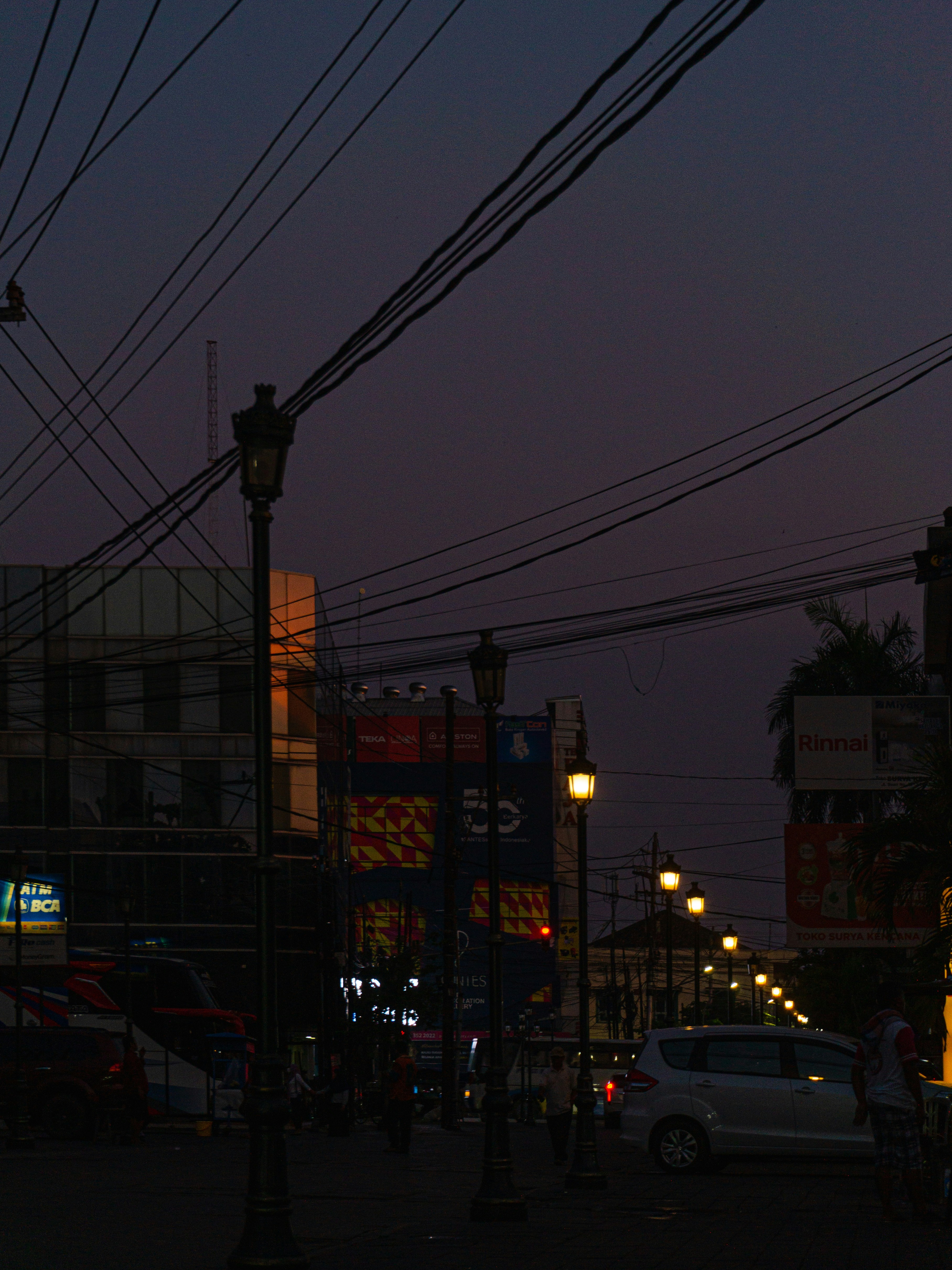 cars on road near buildings during night time
