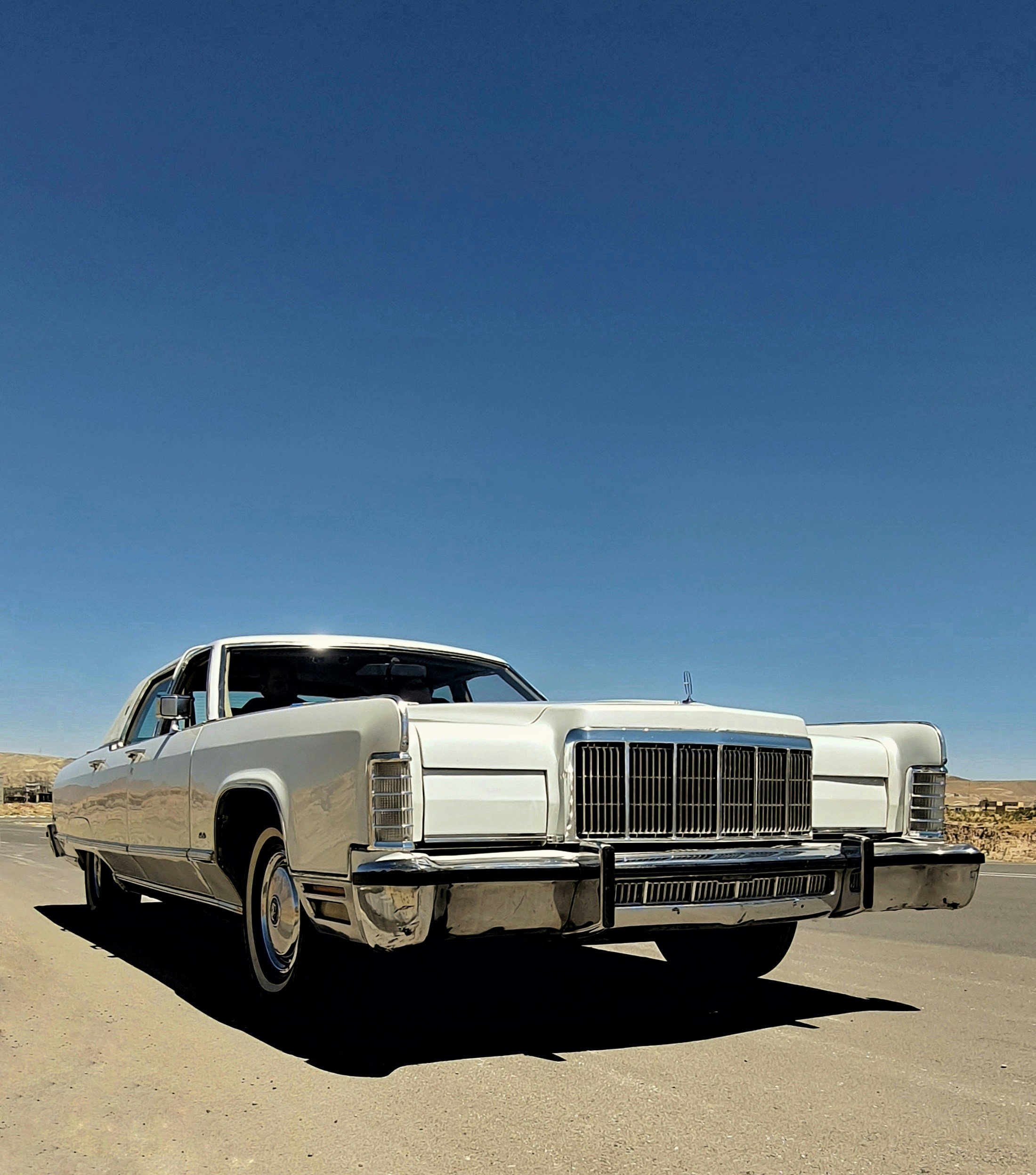 Low-angle Classic: The Angled White Beast Rests on Desert Road