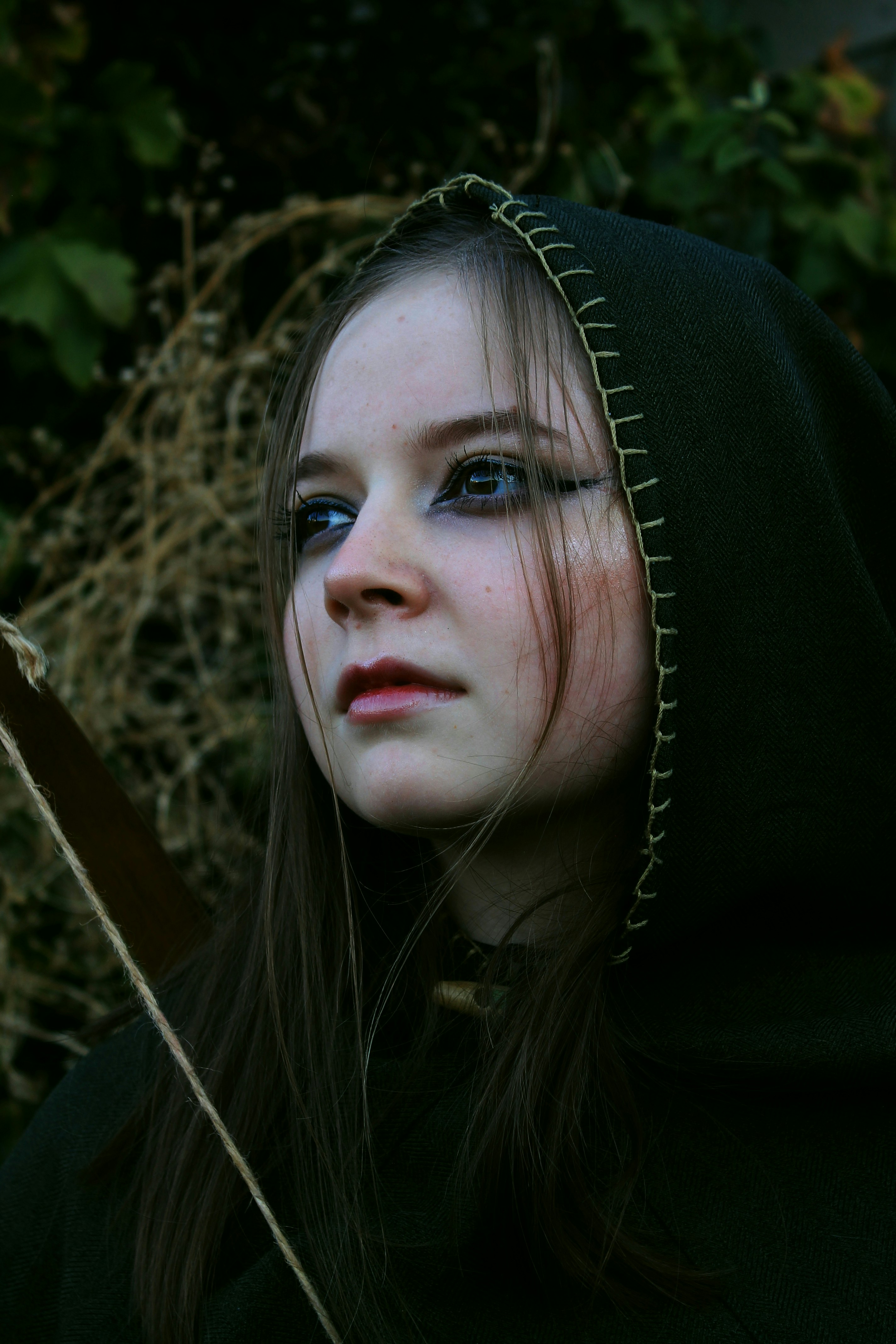Glimpse Beneath the Hood: Portrait in Dappled Shade