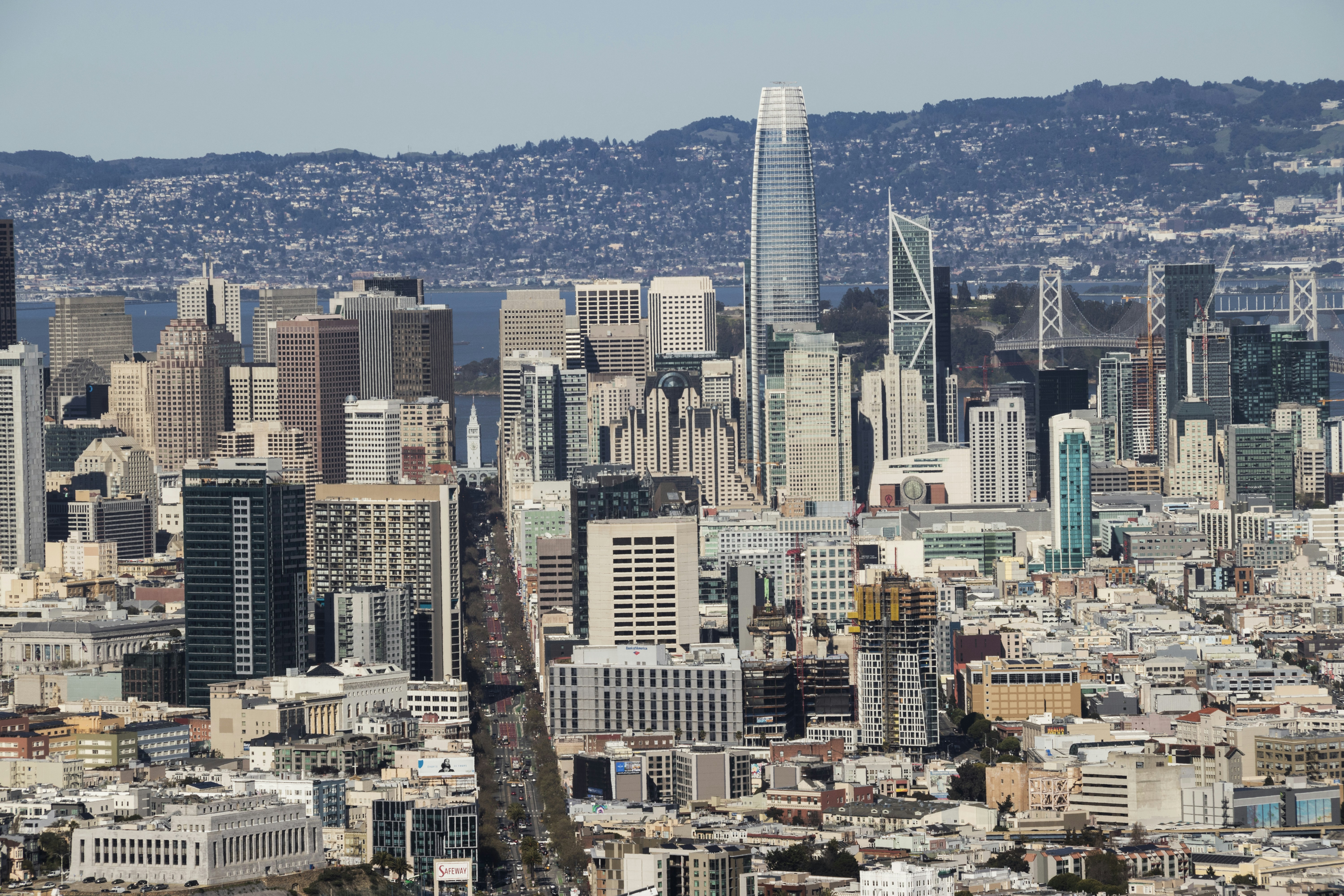 Aerial view of San Francisco showcasing a vibrant cityscape with iconic skyscrapers and the Bay Bridge in the background.