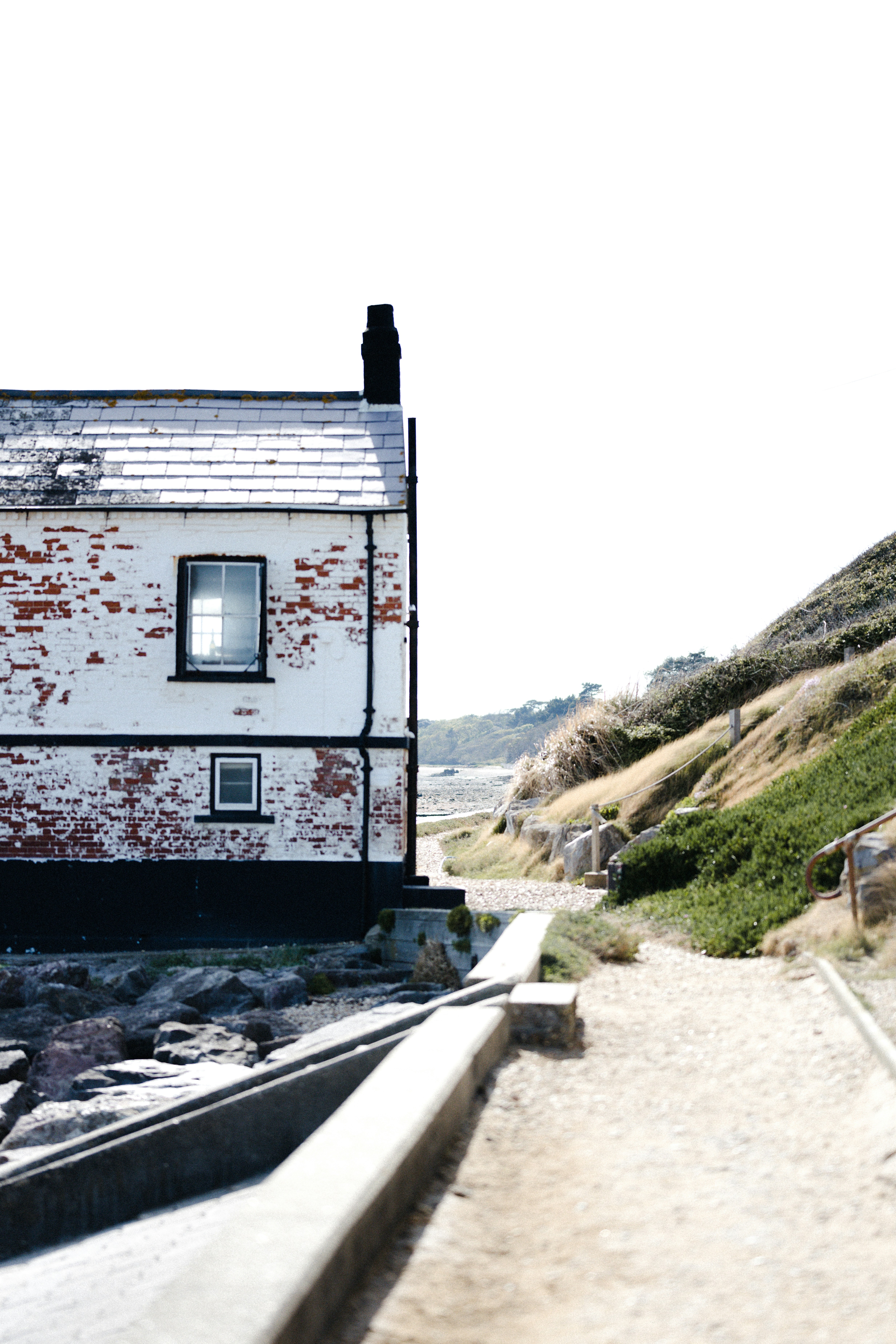 Saltwashed White Cottage Guarded by a Pebble Path