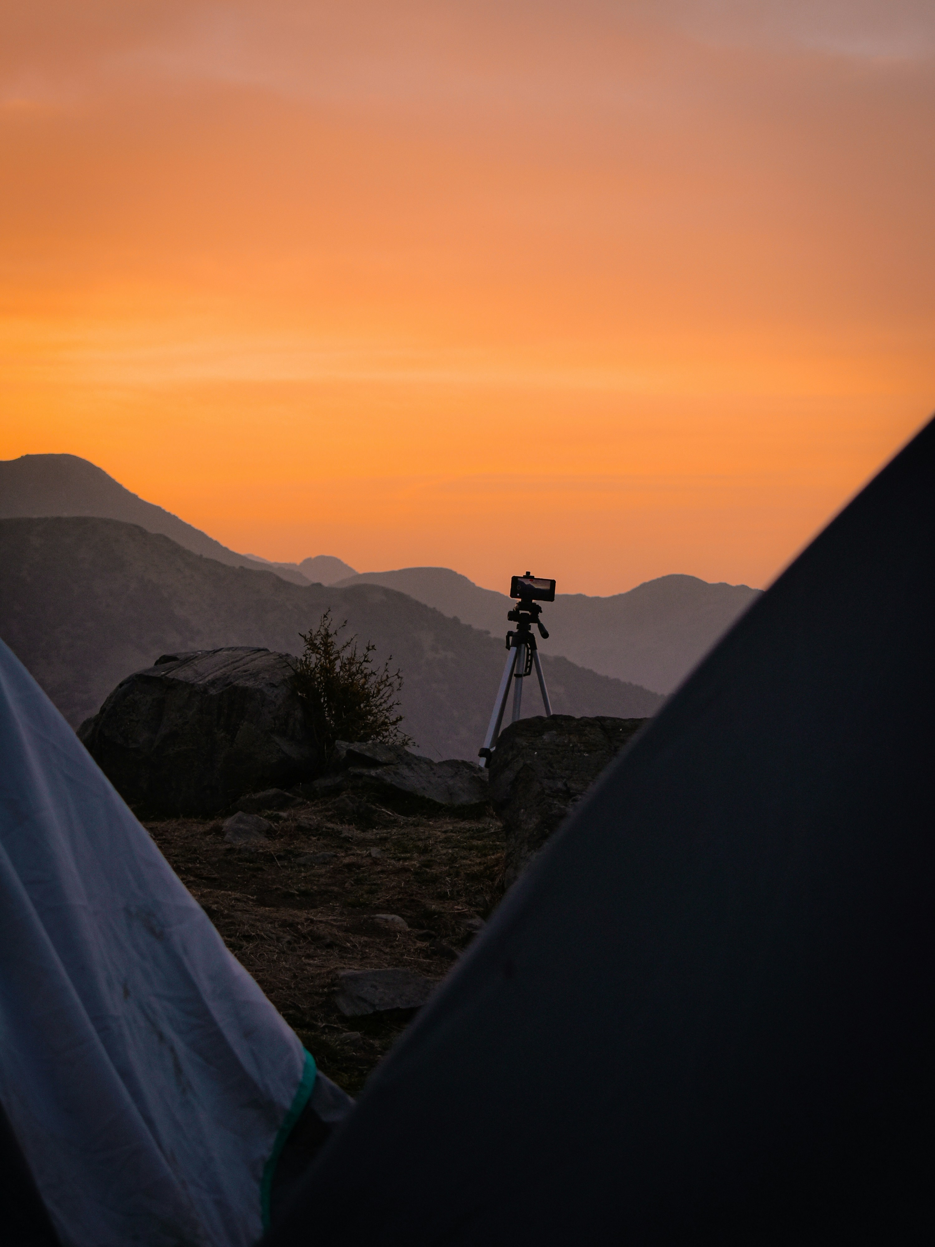 Twilight Observatory: Tripod Stands Between Tents and Distant Peaks