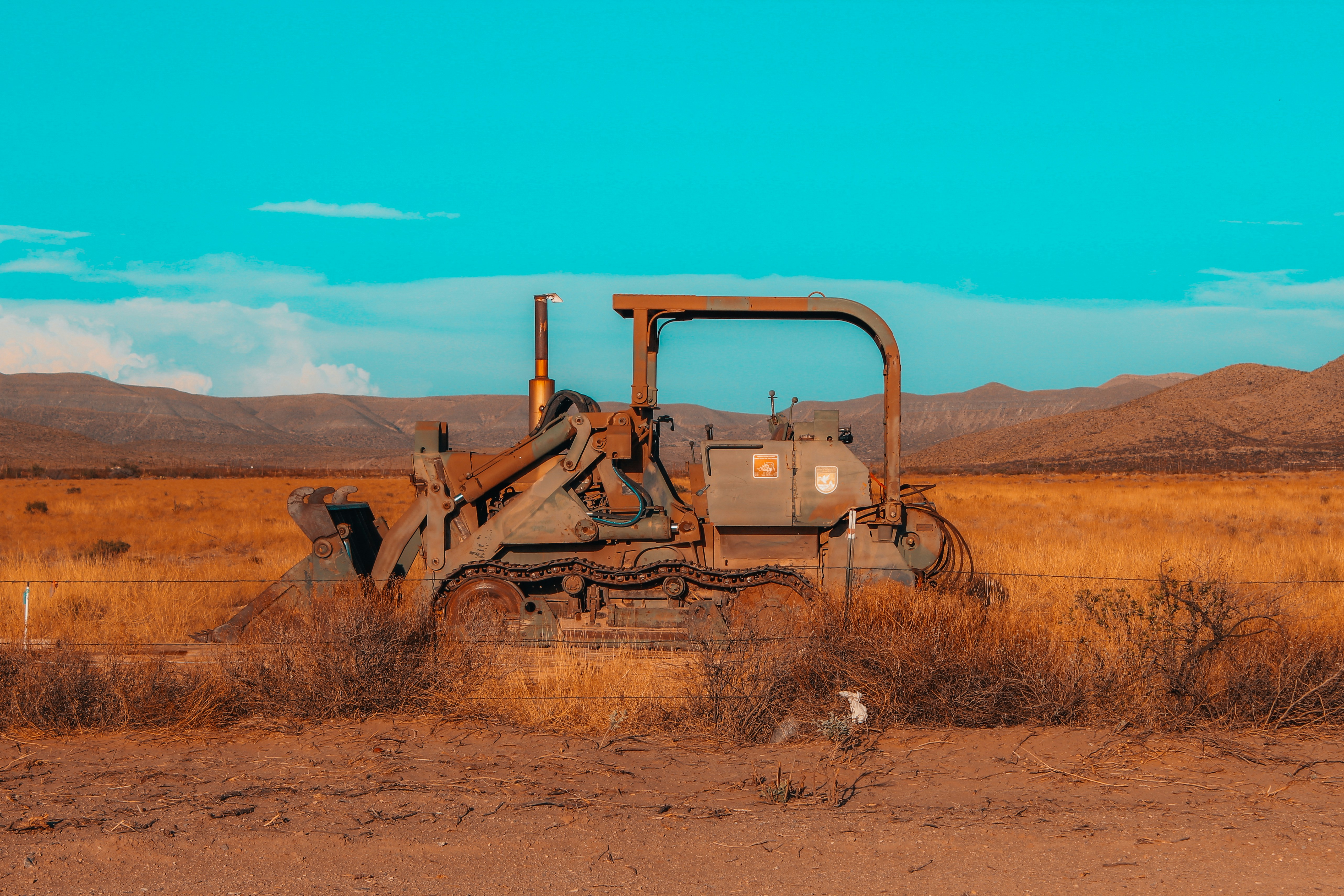 Brown and black heavy equipment on brown field under blue sky during ...