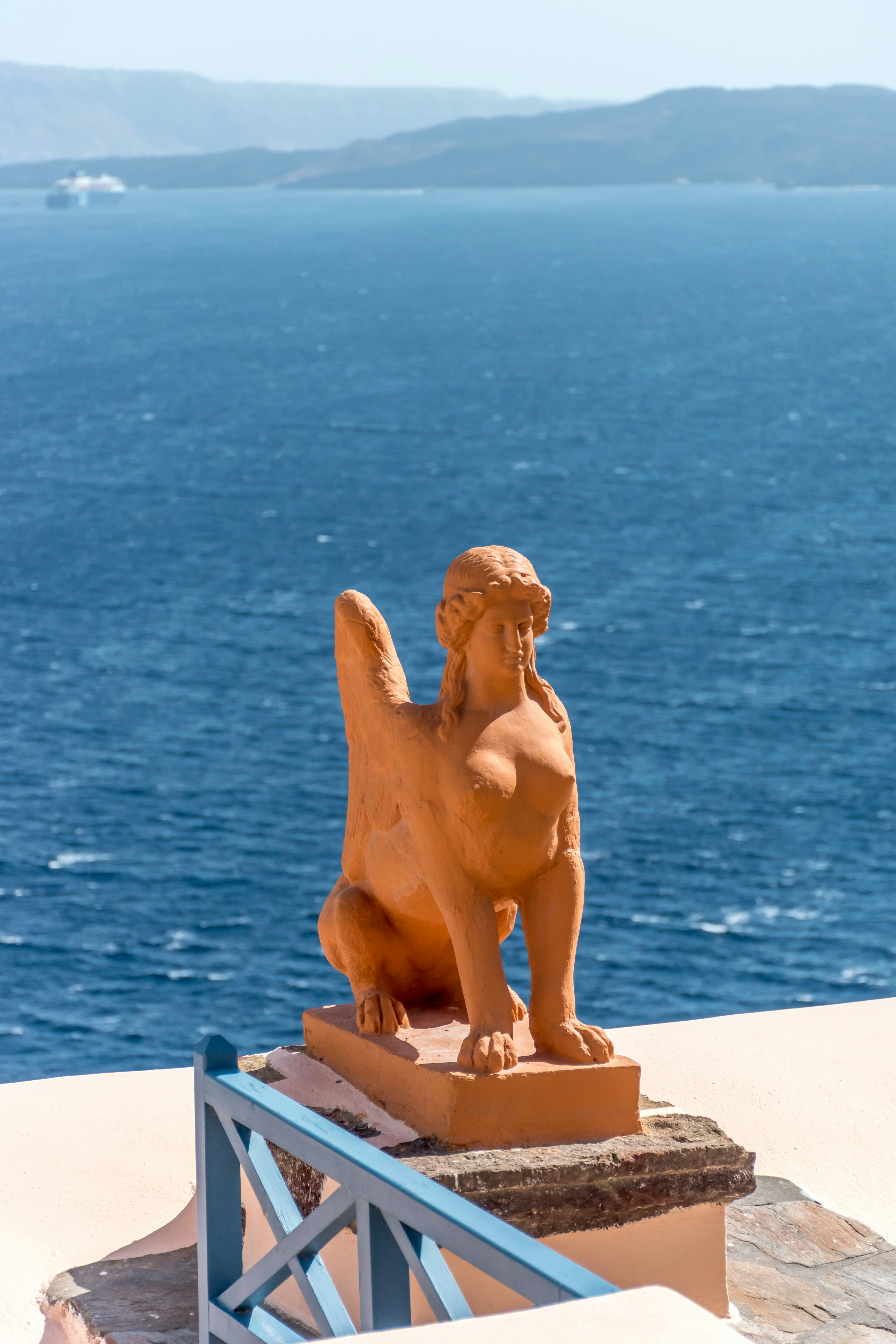 Terracotta Sphinx on a Sunlit Terrace Over the Blue Sea