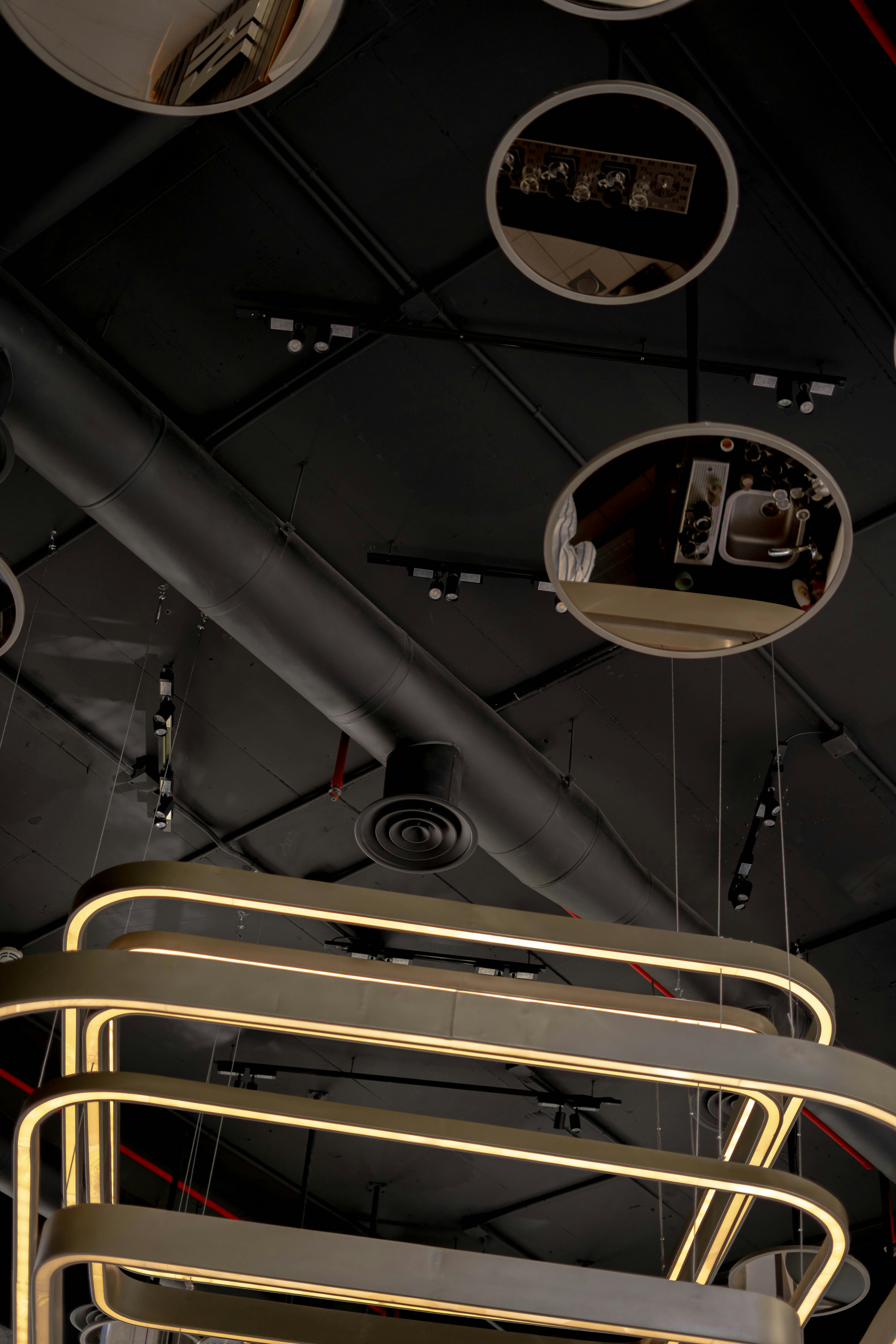 Rimmed Light Orbits: Suspended Glow Amid Industrial Ductwork