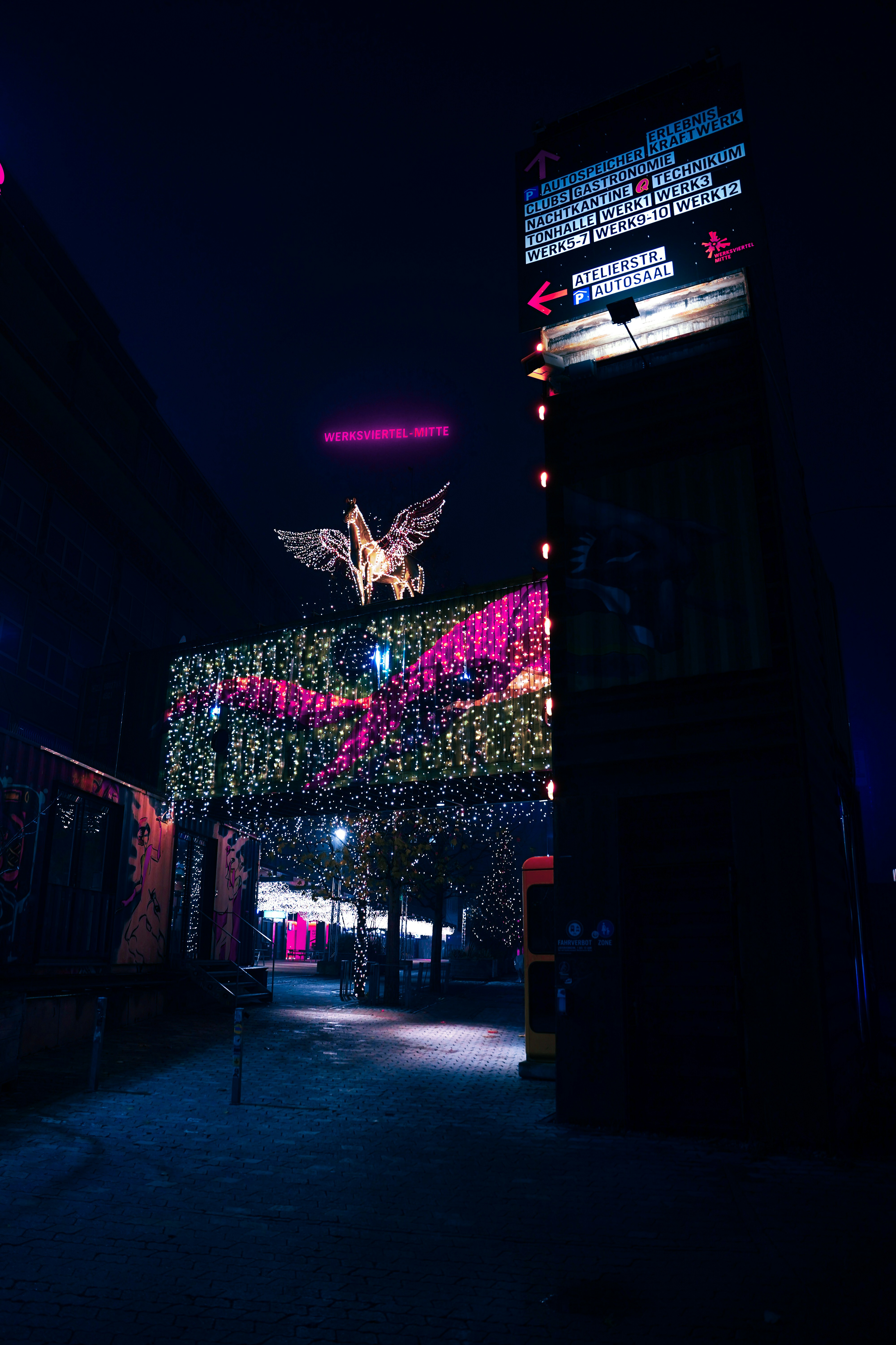 Angel Over Neon Canopy: A Winter Night Under Festive Lights