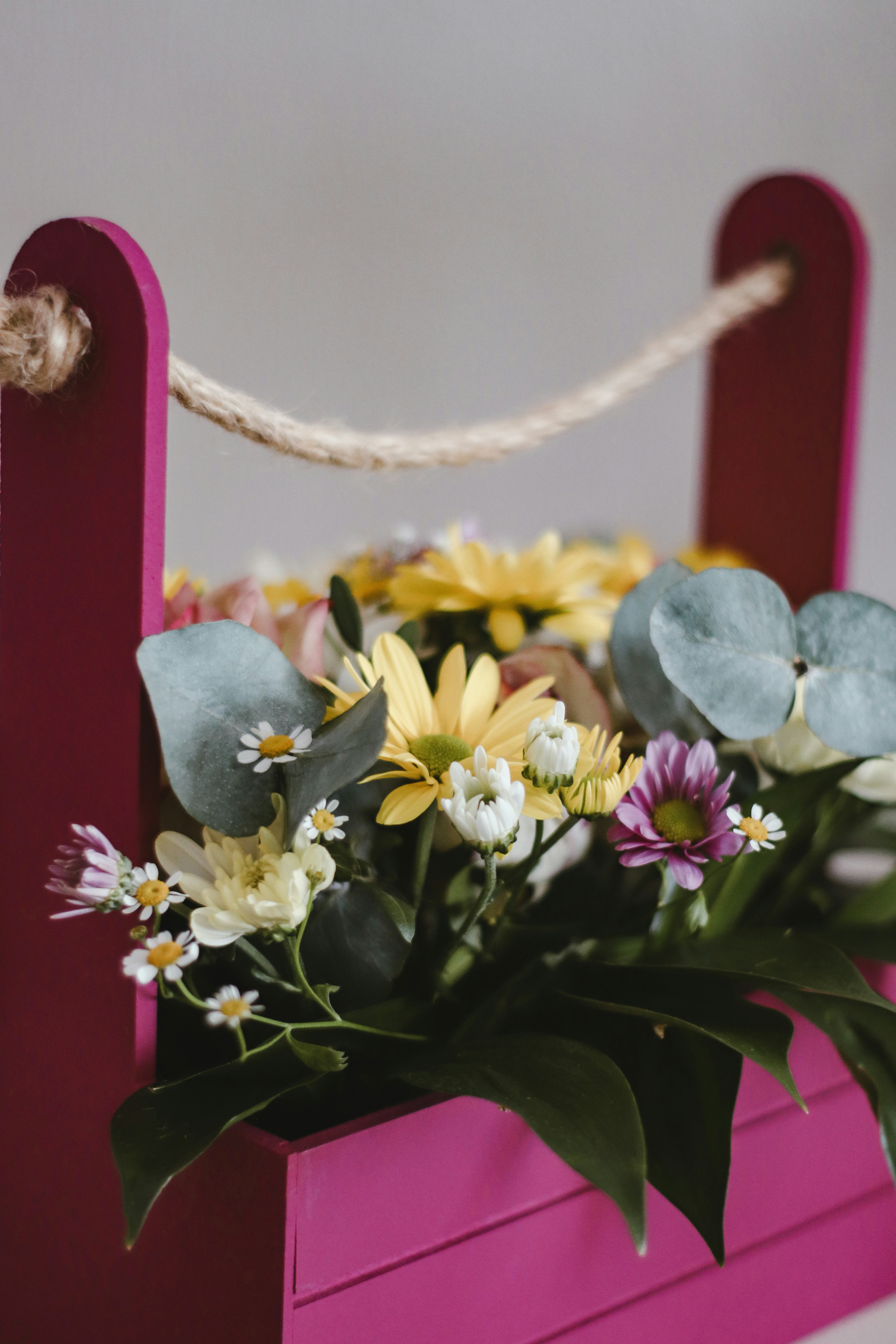 Pink tote of blossoms: a bright floral arrangement in a vivid container