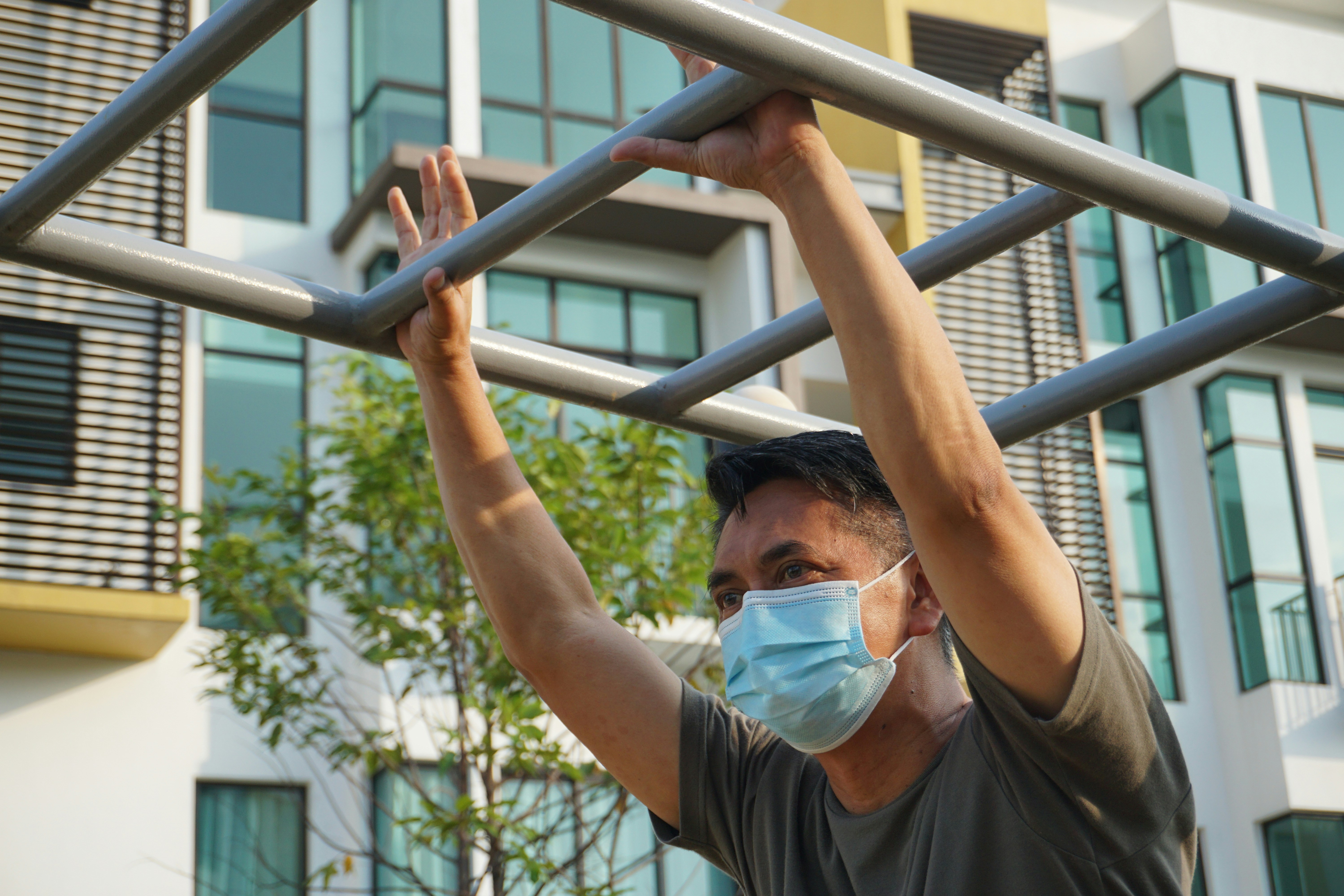 Rising to the Challenge: Grasping the Metal Frame under a Clear Sky