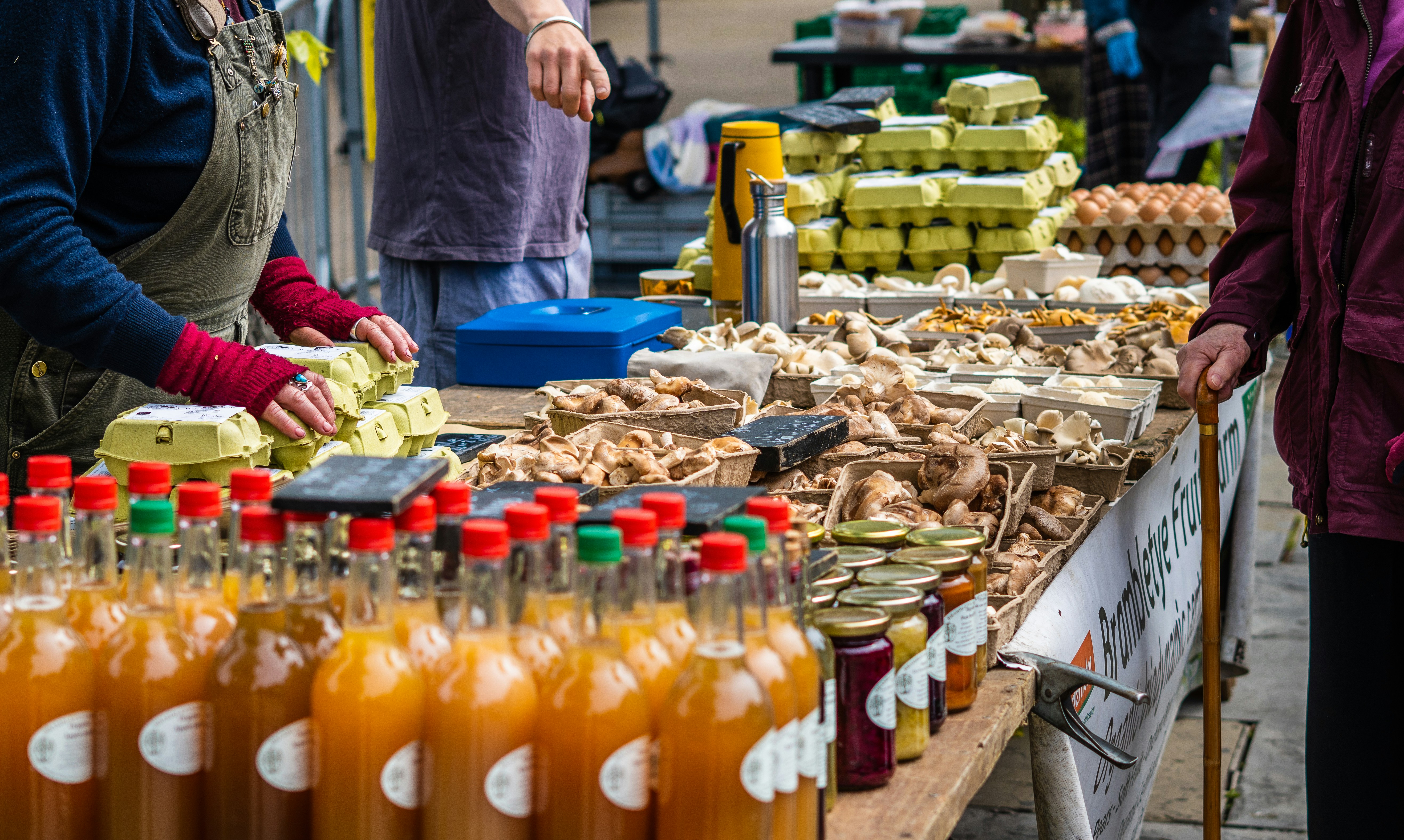 Morning Market Stand: Bottled Drinks, Jars and Pastries at a Bustling Stall