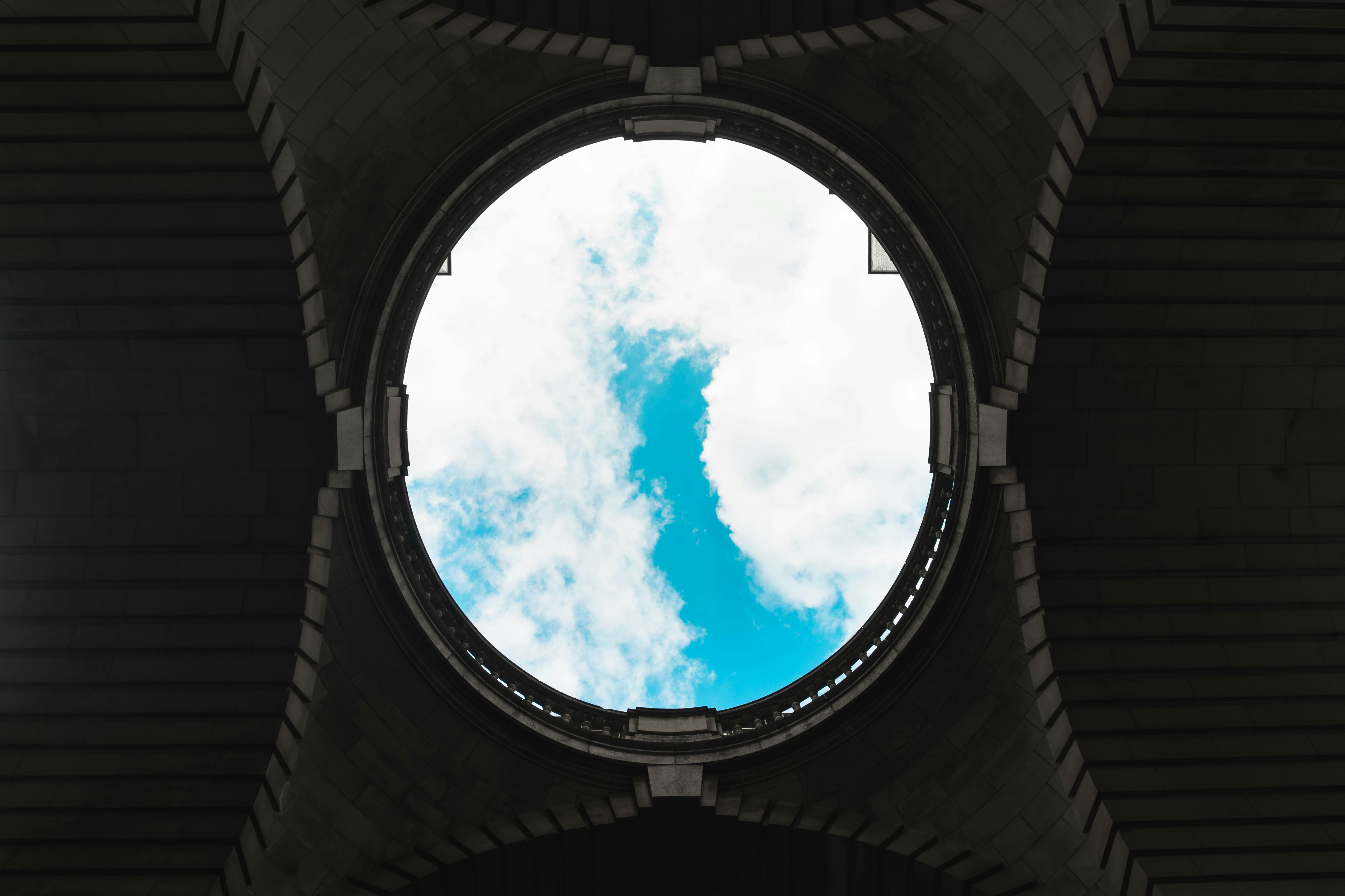 Oculus of Light: Sky Through a Dark Atrium