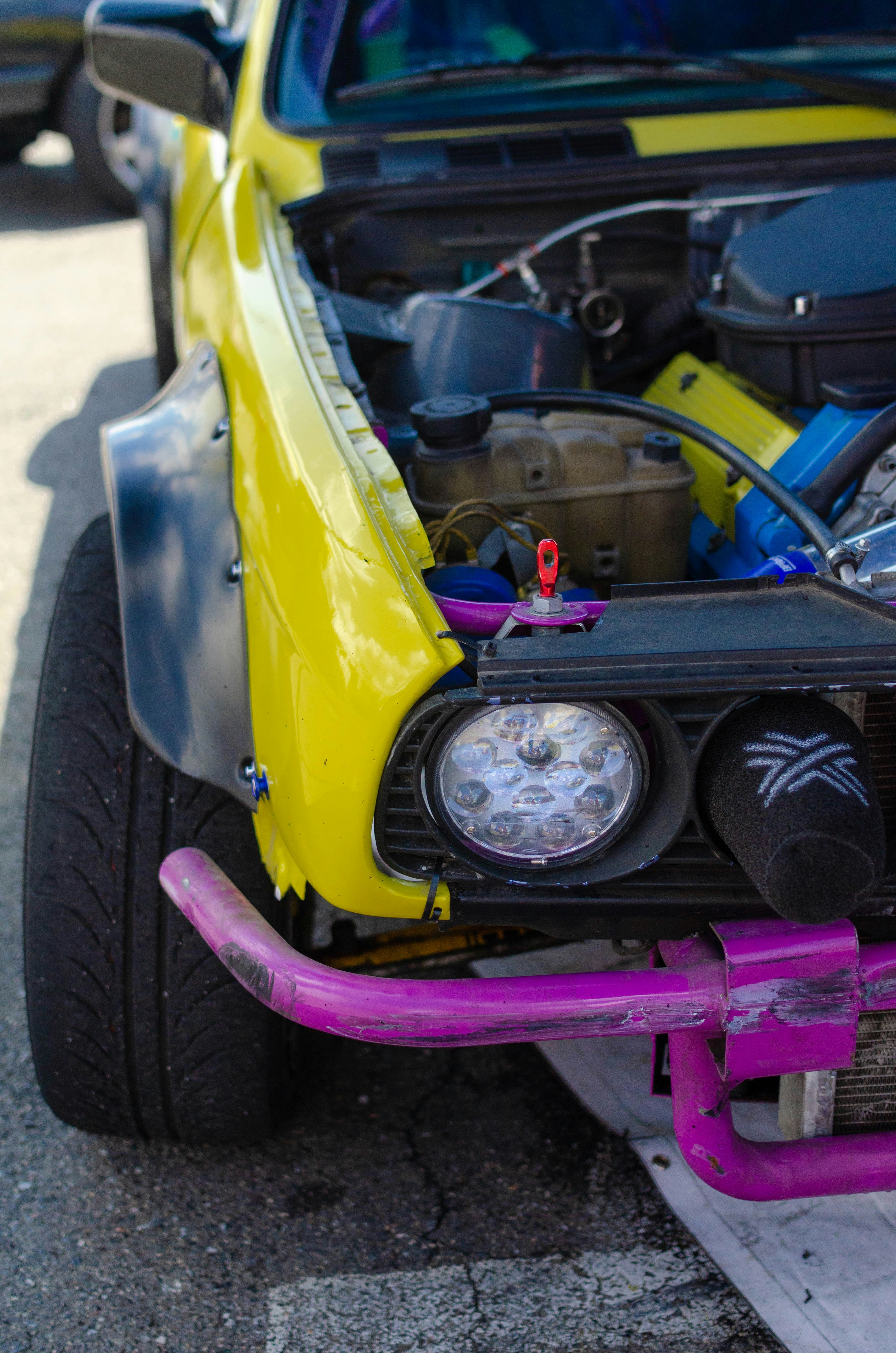 Front-Quarter Neon: Bold Yellow Custom with Magenta Exhaust and Prominent Headlamp