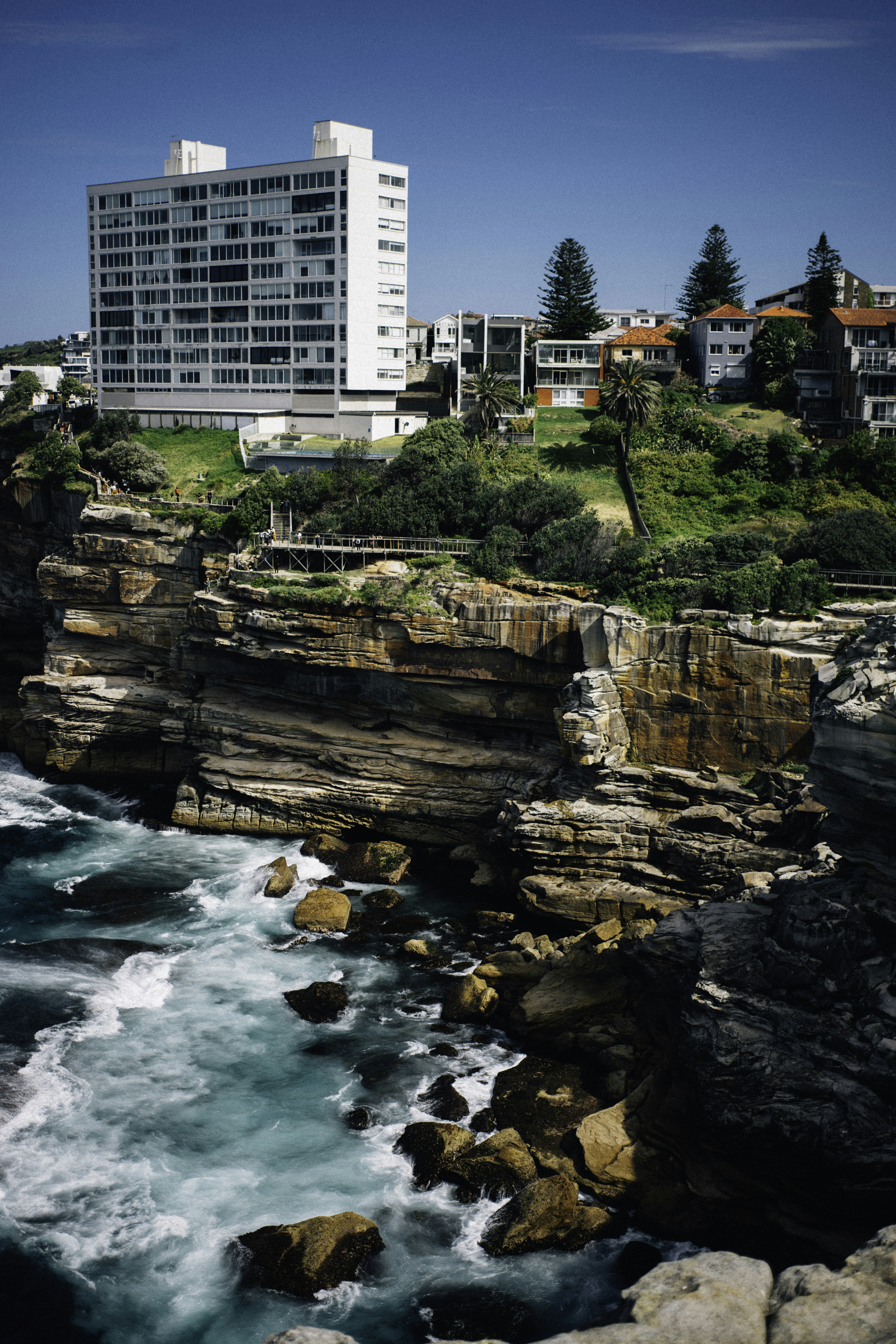 Clifftop Retreat: Modern Building Overlook Against Turquoise Tide