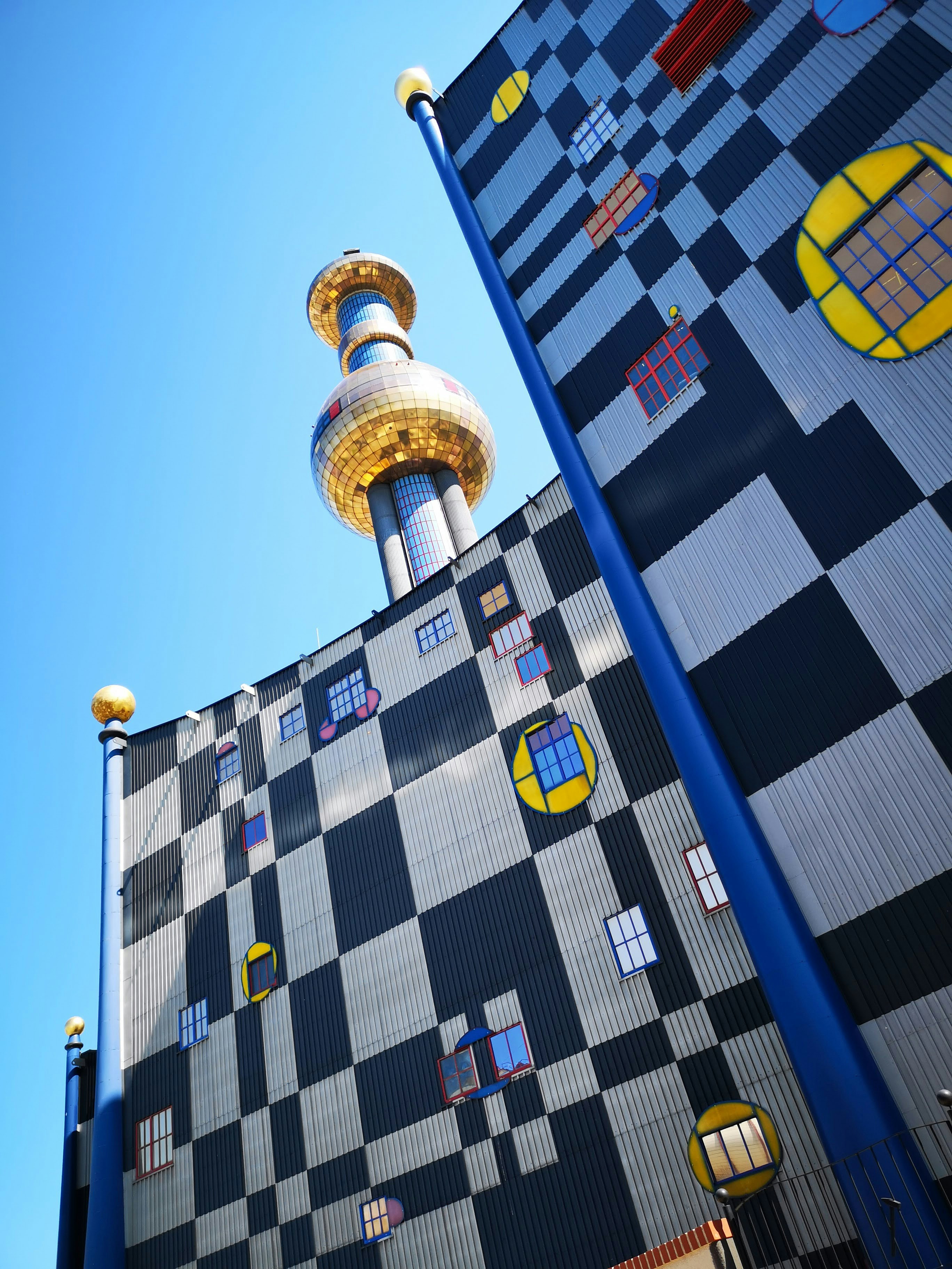 Golden Tower Against a Checkerboard Sky: A Tilted City Portrait