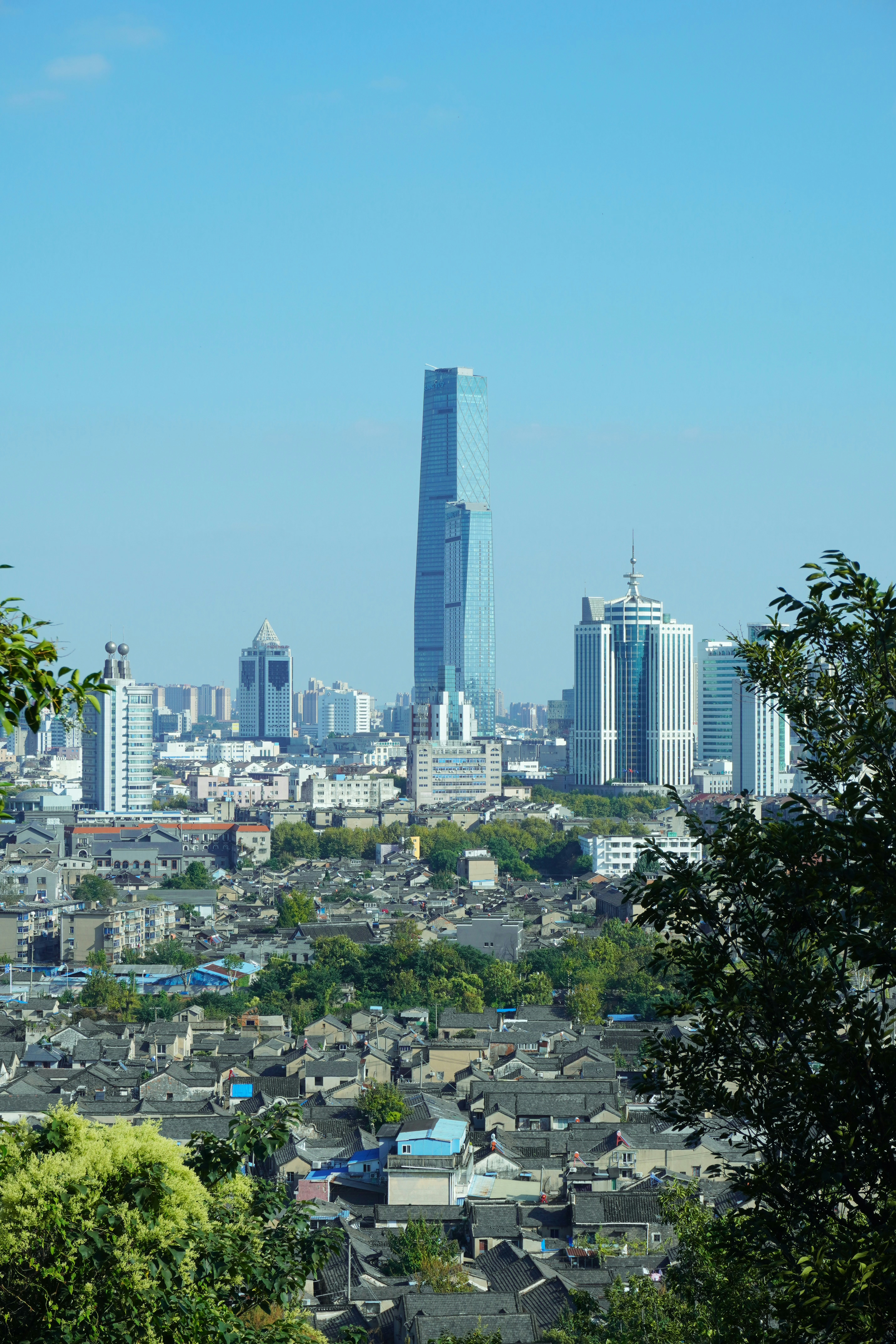 A panoramic view showcasing a modern skyline juxtaposed with traditional rooftops, highlighting the blend of old and new architecture in a vibrant cityscape.