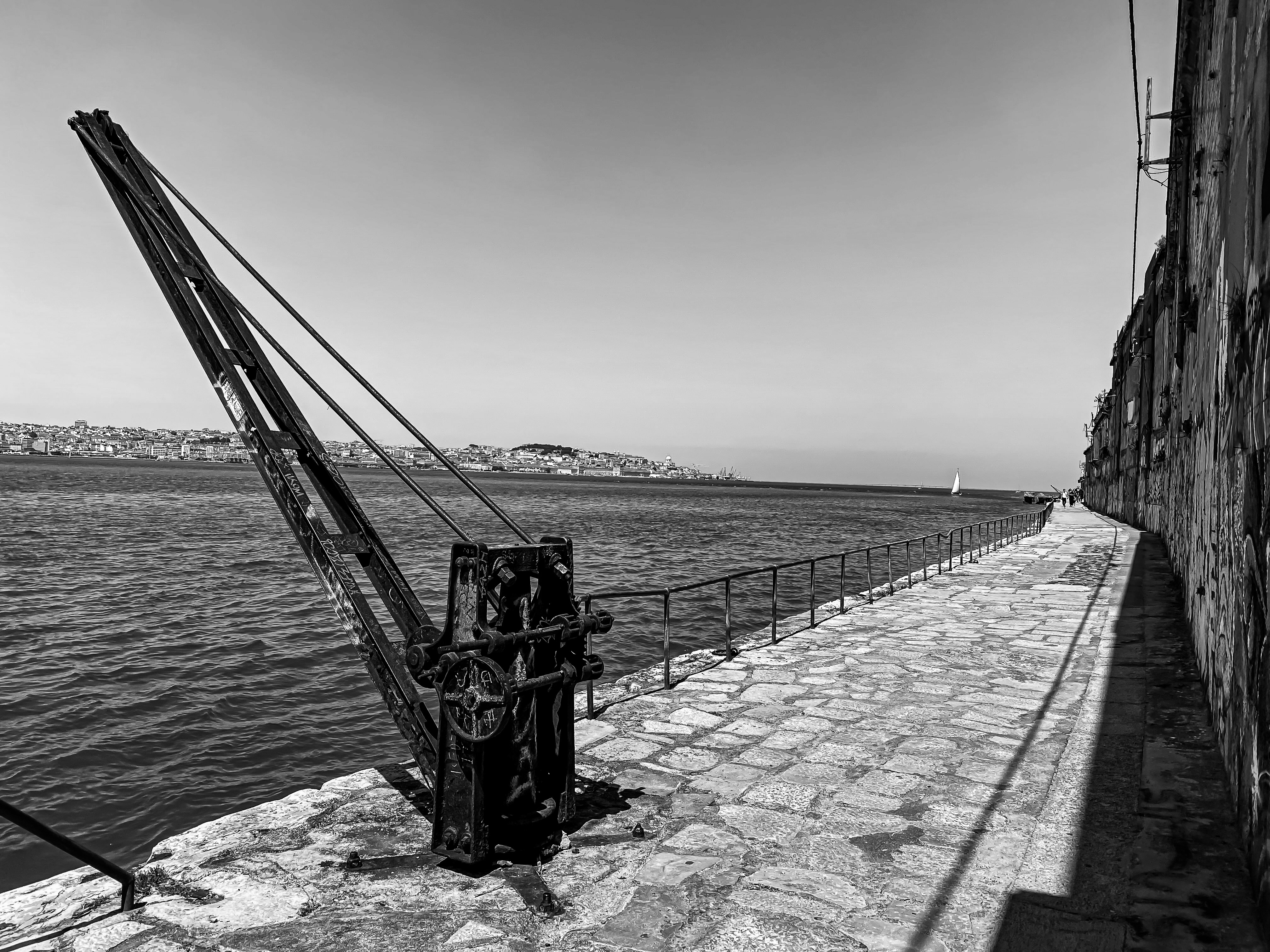 Harbor Edge: A Weathered Crane Guards the Quiet Promenade