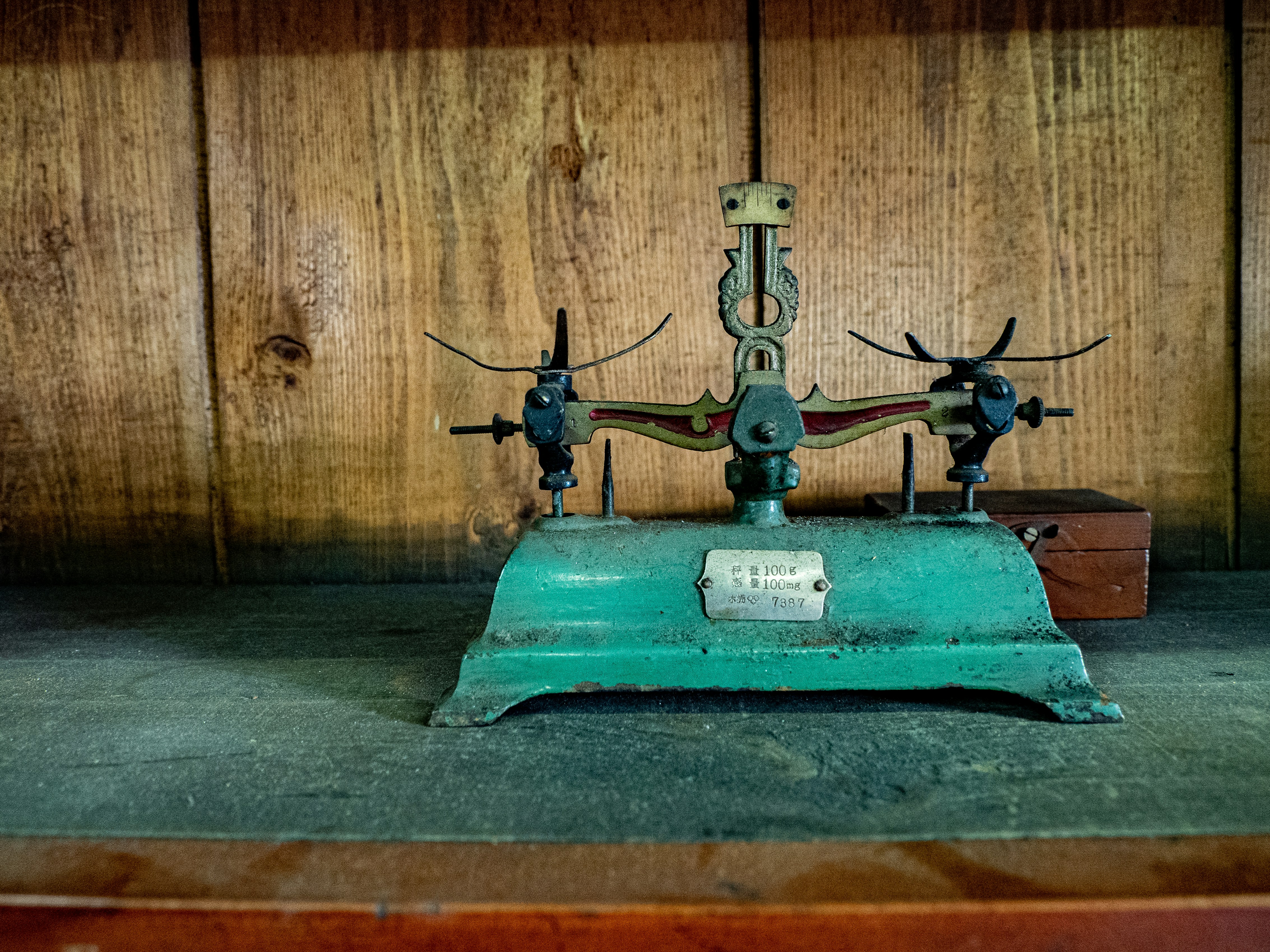 Teal Timeworn Balance Scale in a Quiet Workshop