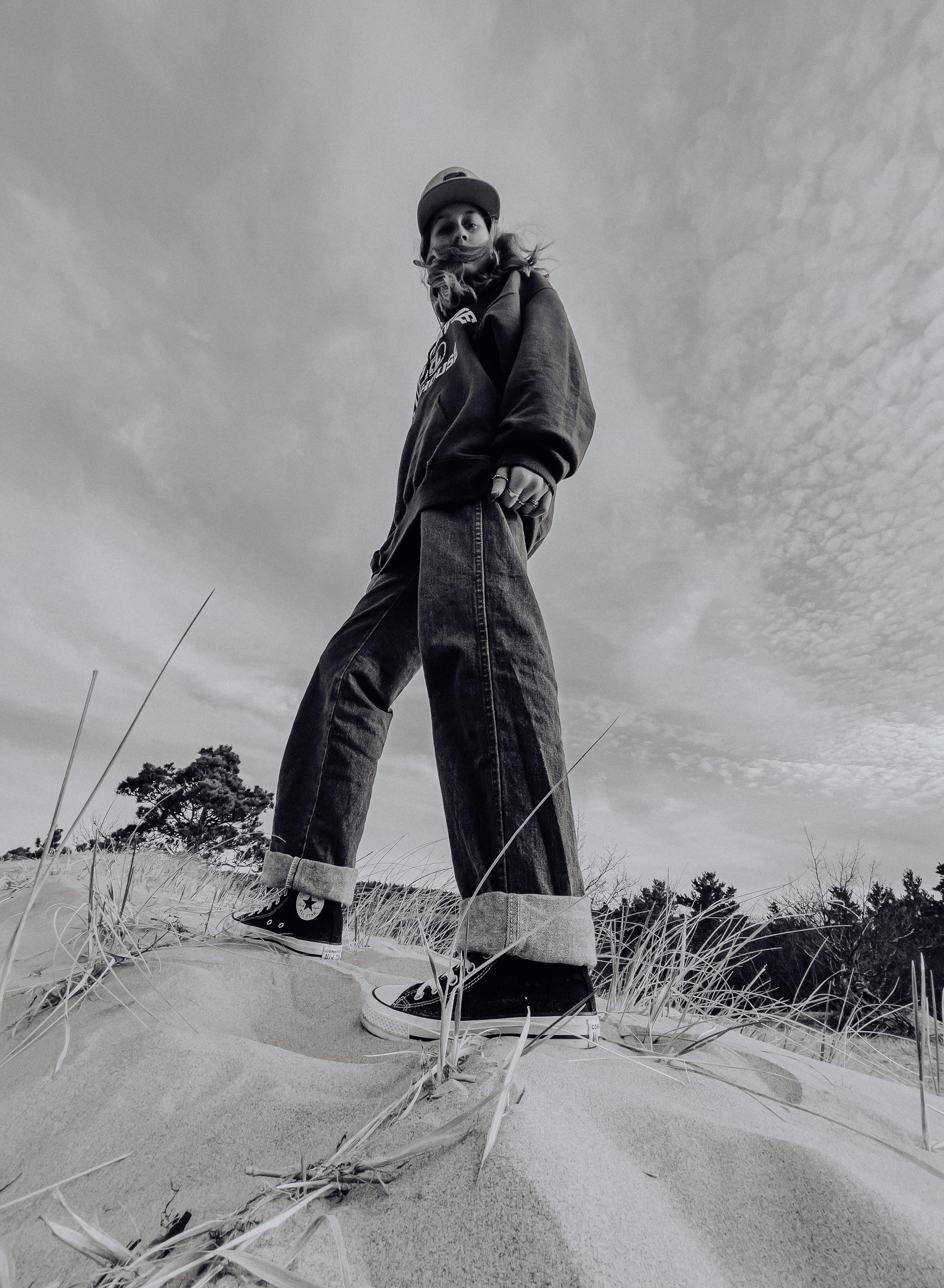 Low-angled stride: a lone figure dominates a windswept dune