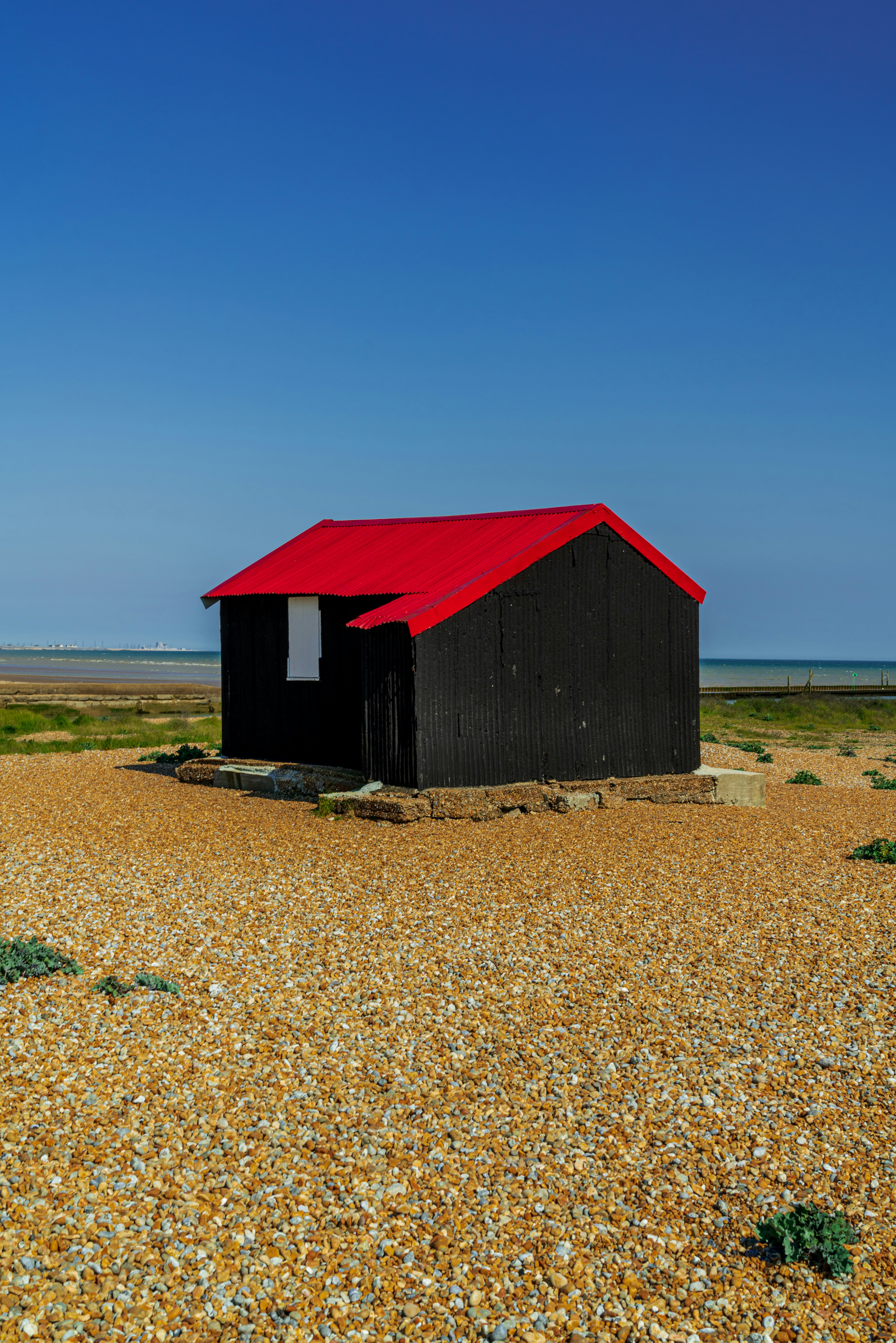 The red roof hut on the Camber Sands estuary.