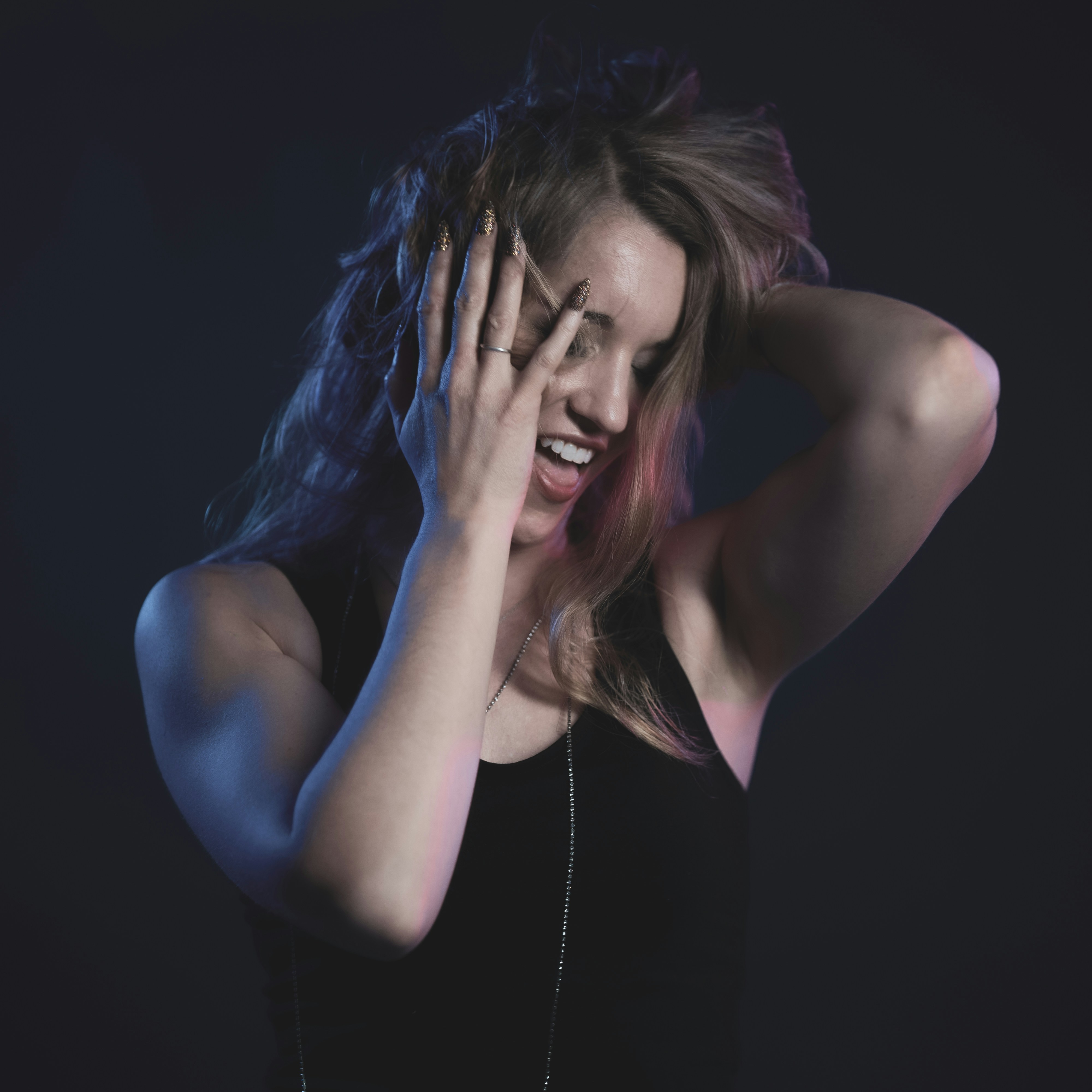 Shadows and Smiles: Neon-Tinted Studio Portrait