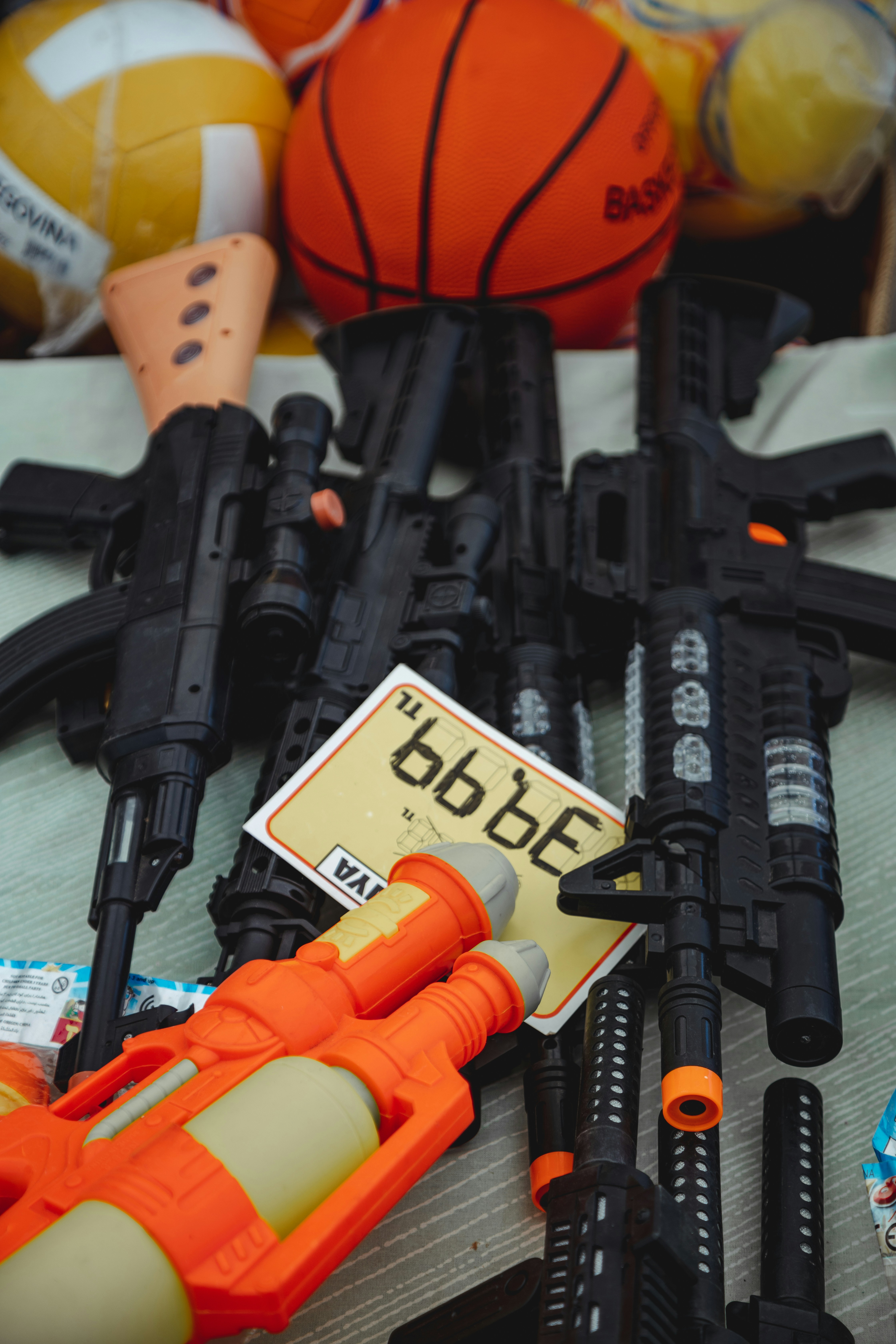 Orange-Accent Toy Arsenal Beneath a Ball Parade