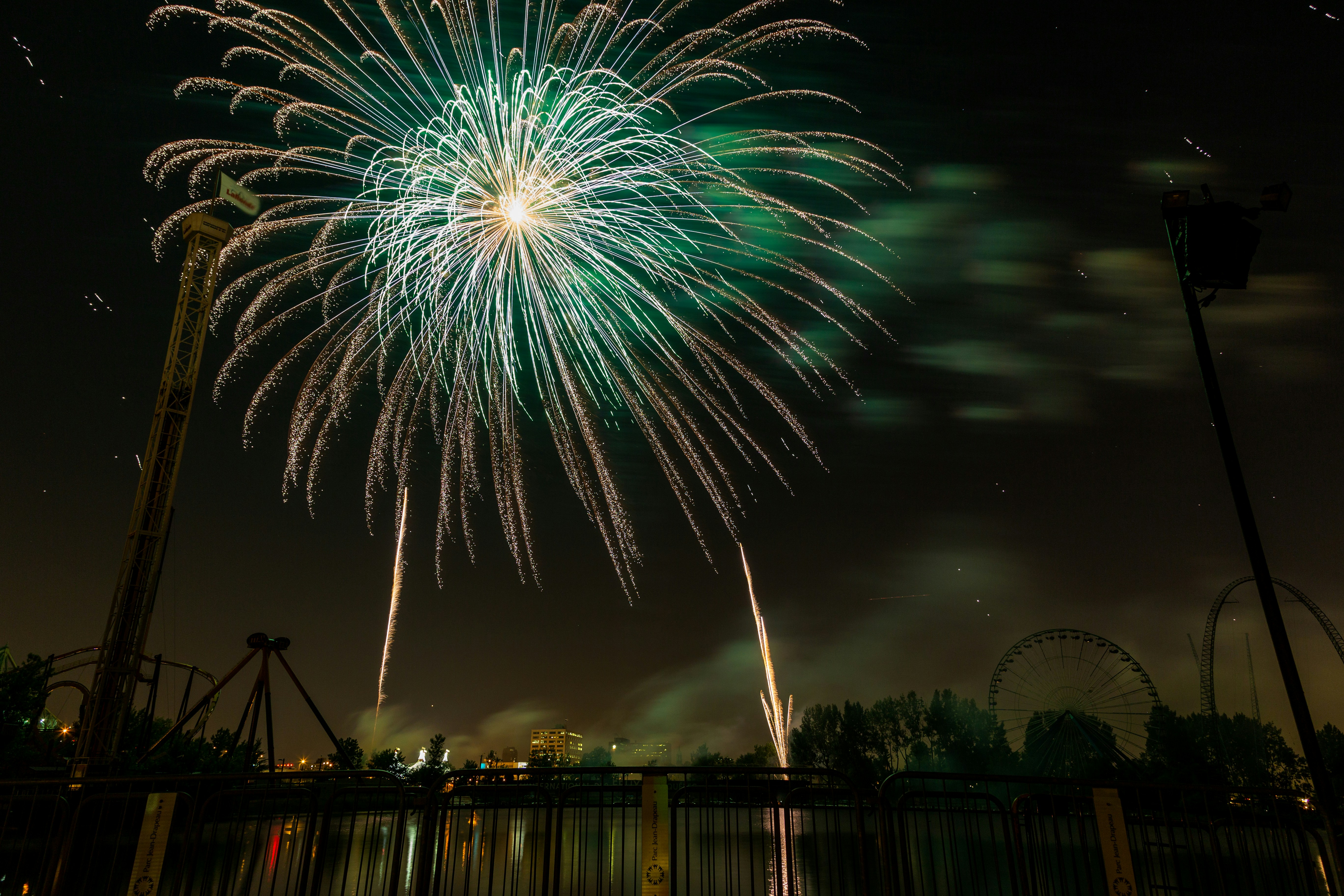 Emerald Burst Over the Riverfront Sky