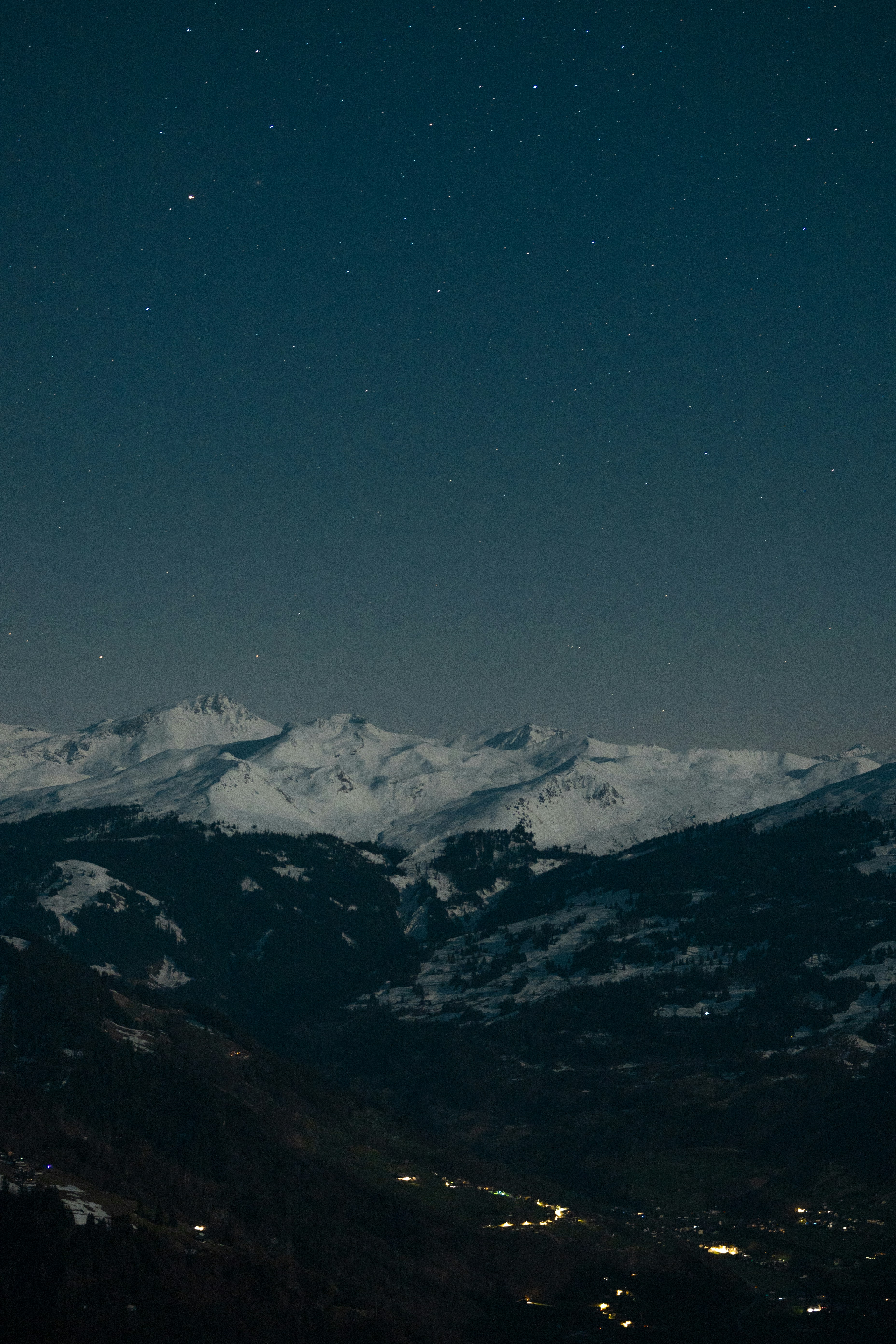 Moonlit Valleys beneath a Starfield Over the Alpine Ridge