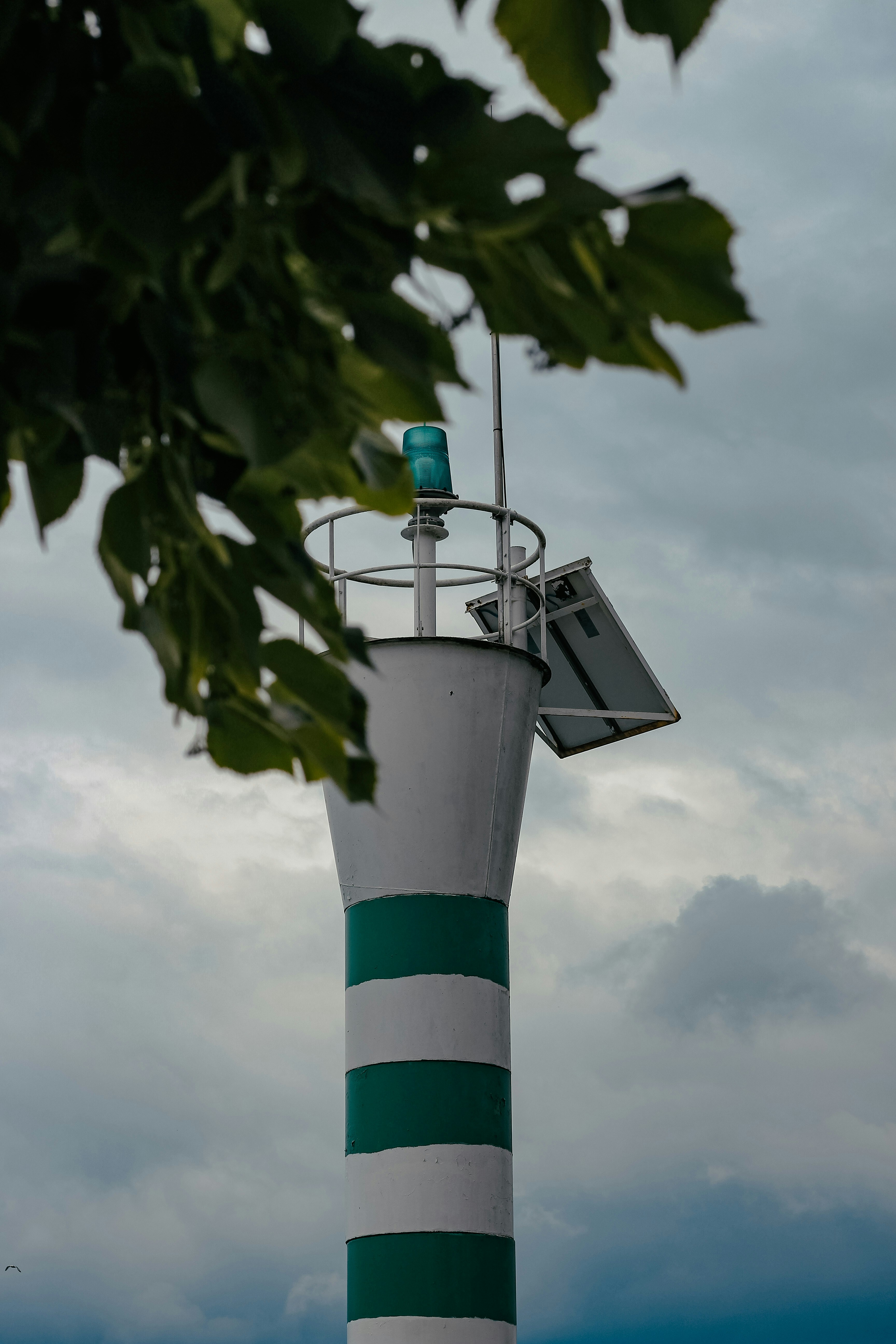 Beacon in Striped Armor Beneath a Clouded Sky
