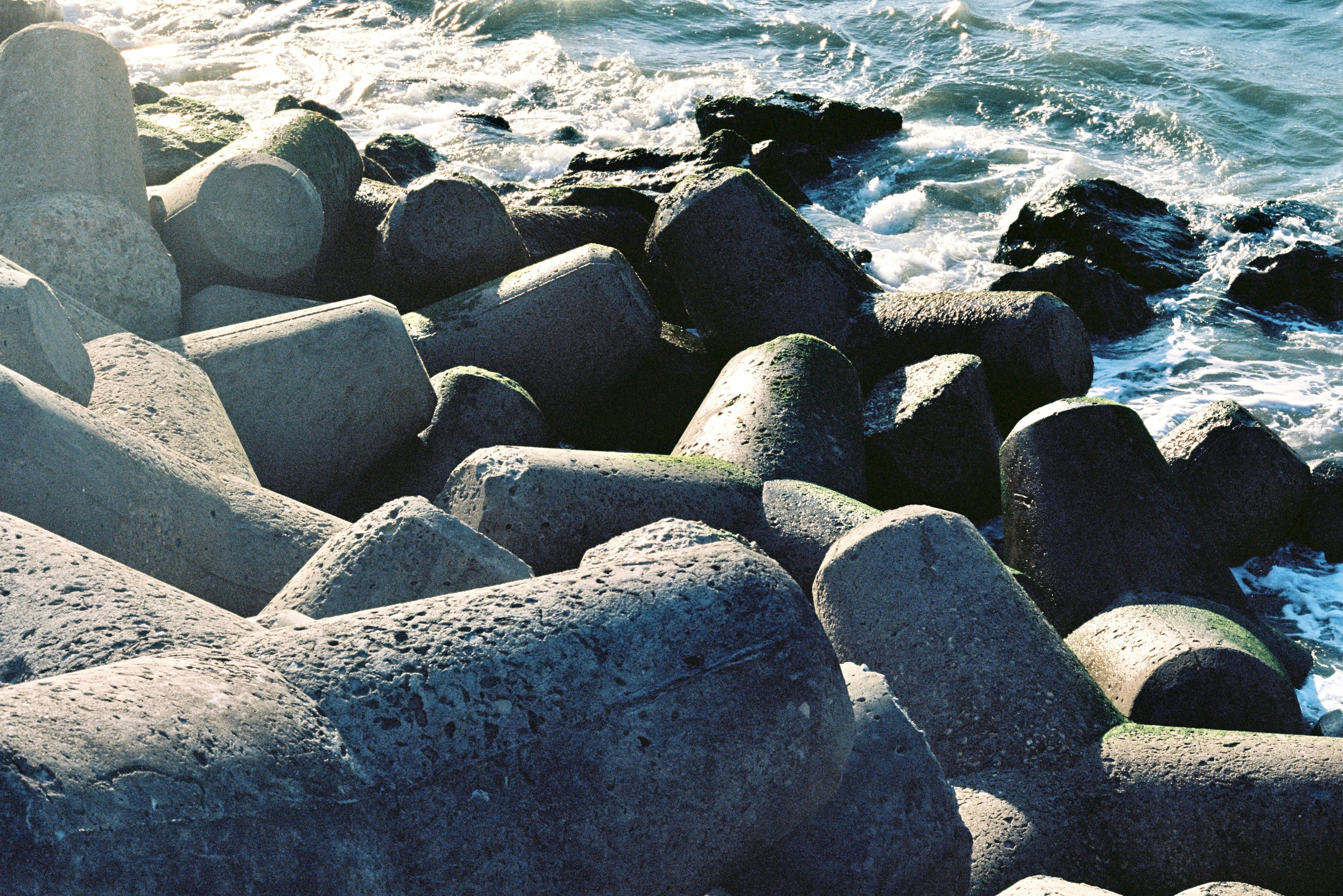 Gray and black rocks near body of water during daytime photo – Free ...