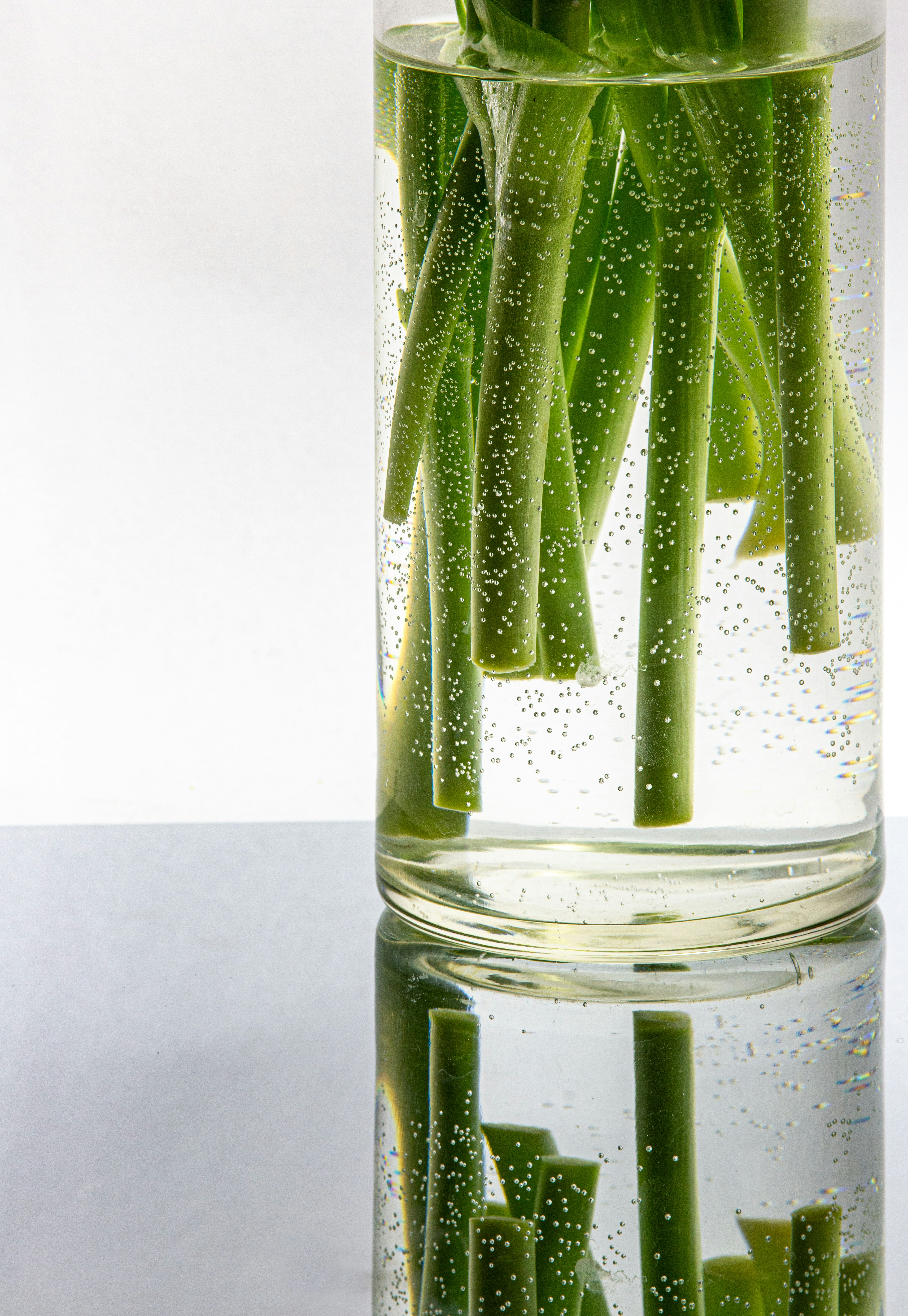 Emerald Rods in Glass: A Minimal Still-Life Study