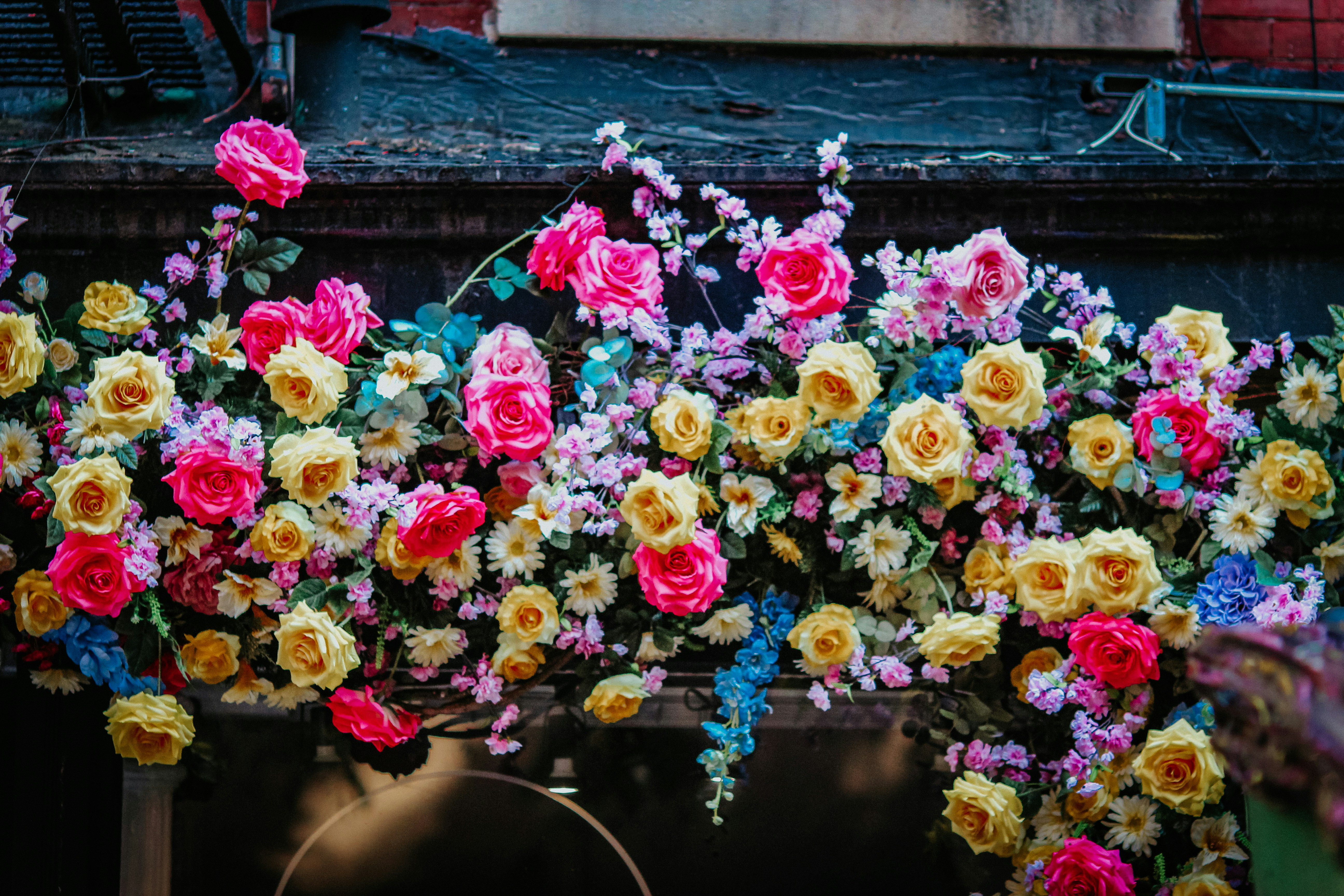 Rosy Cascade Arch in a Market: A Burst of Pink, Yellow, and Blue Roses