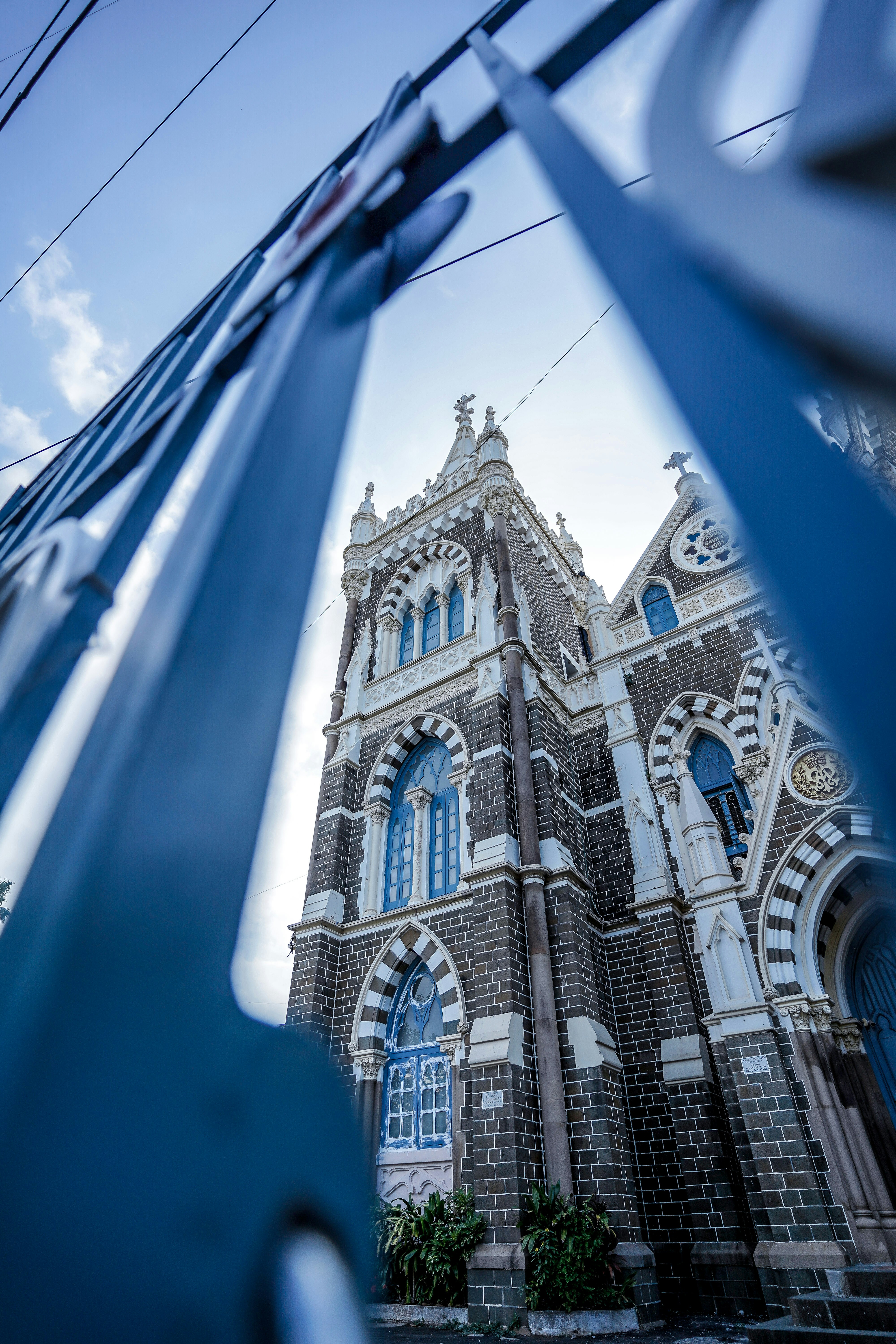 Framed Gothic Cathedral Through a Blue Iron Barrier